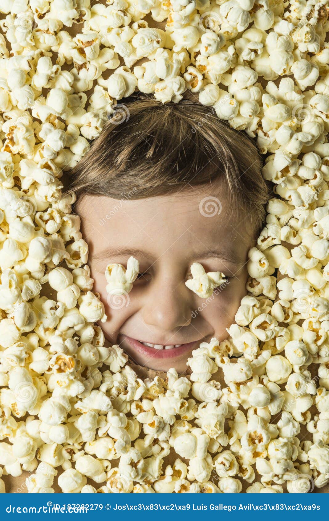 Portrait of a Boy with His Face Surrounded by Popcorn Stock Image ...