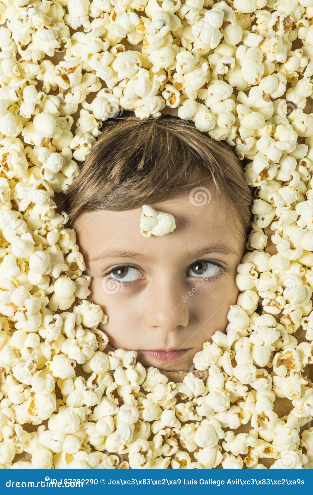 Portrait of a Boy with His Face Surrounded by Popcorn Stock Photo ...