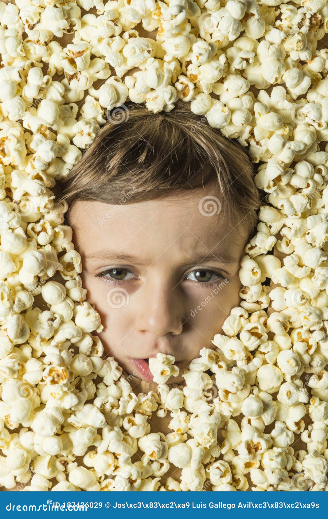Portrait of a Boy with His Face Surrounded by Popcorn Stock Image ...