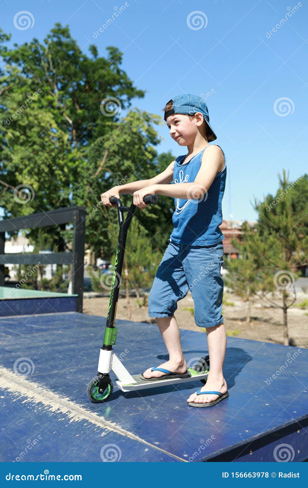 Portrait of boy on scooter stock photo. Image of child - 156663978