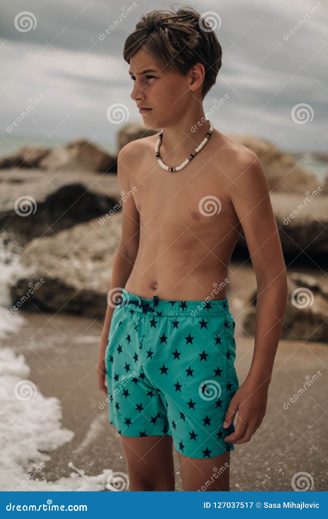 Portrait of a Boy Standing on the Beach with Waves Stock Image - Image ...