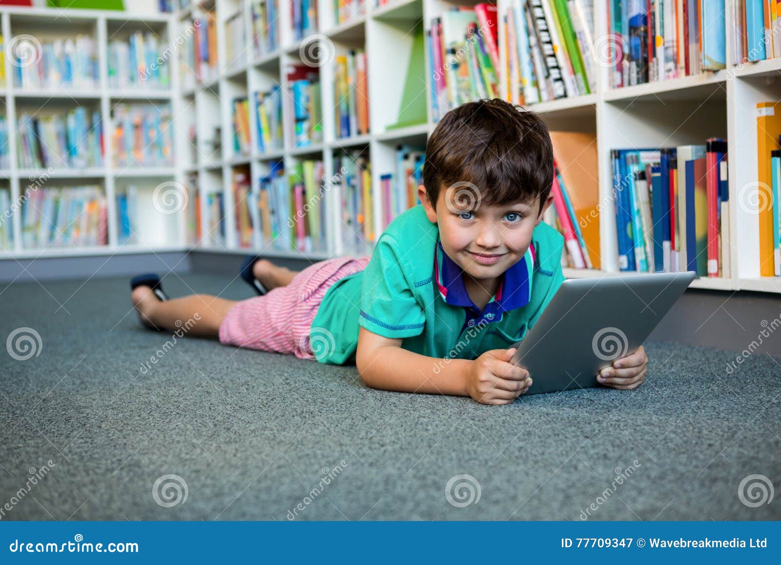 Portrait of Boy Using Digital Tablet in School Library Stock Image ...