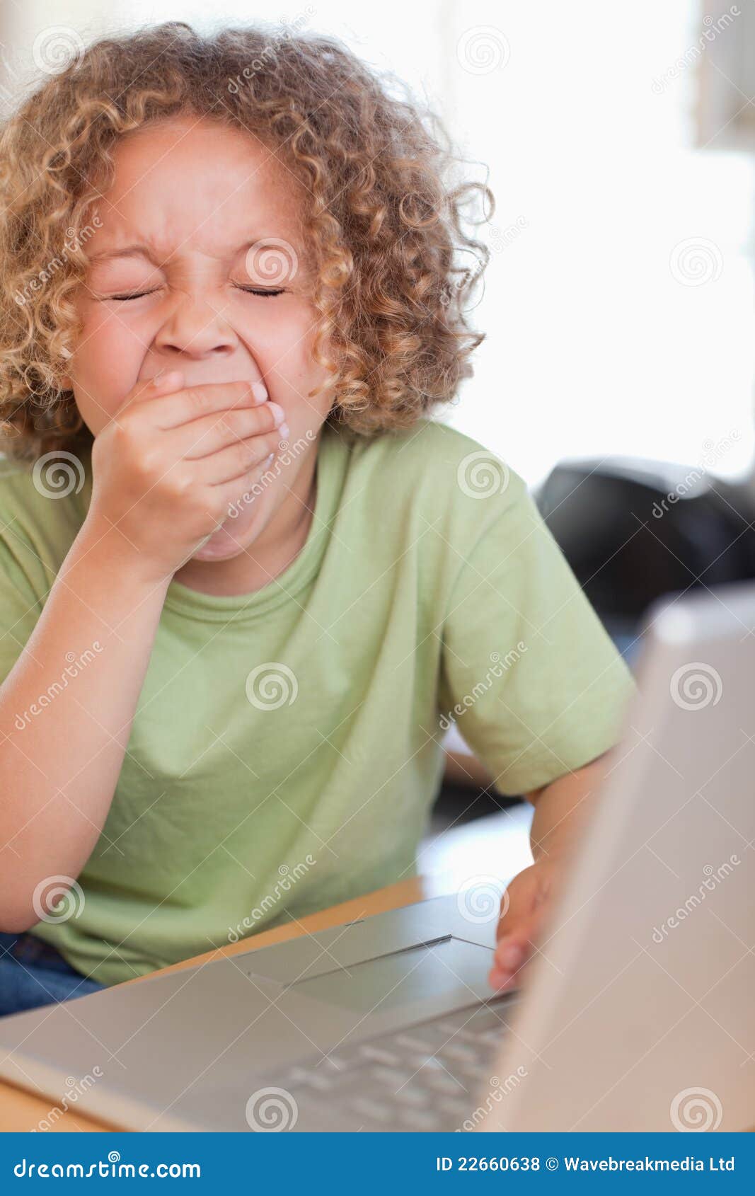 Portrait of a Boy Yawning while Using a Laptop Stock Photo - Image of ...