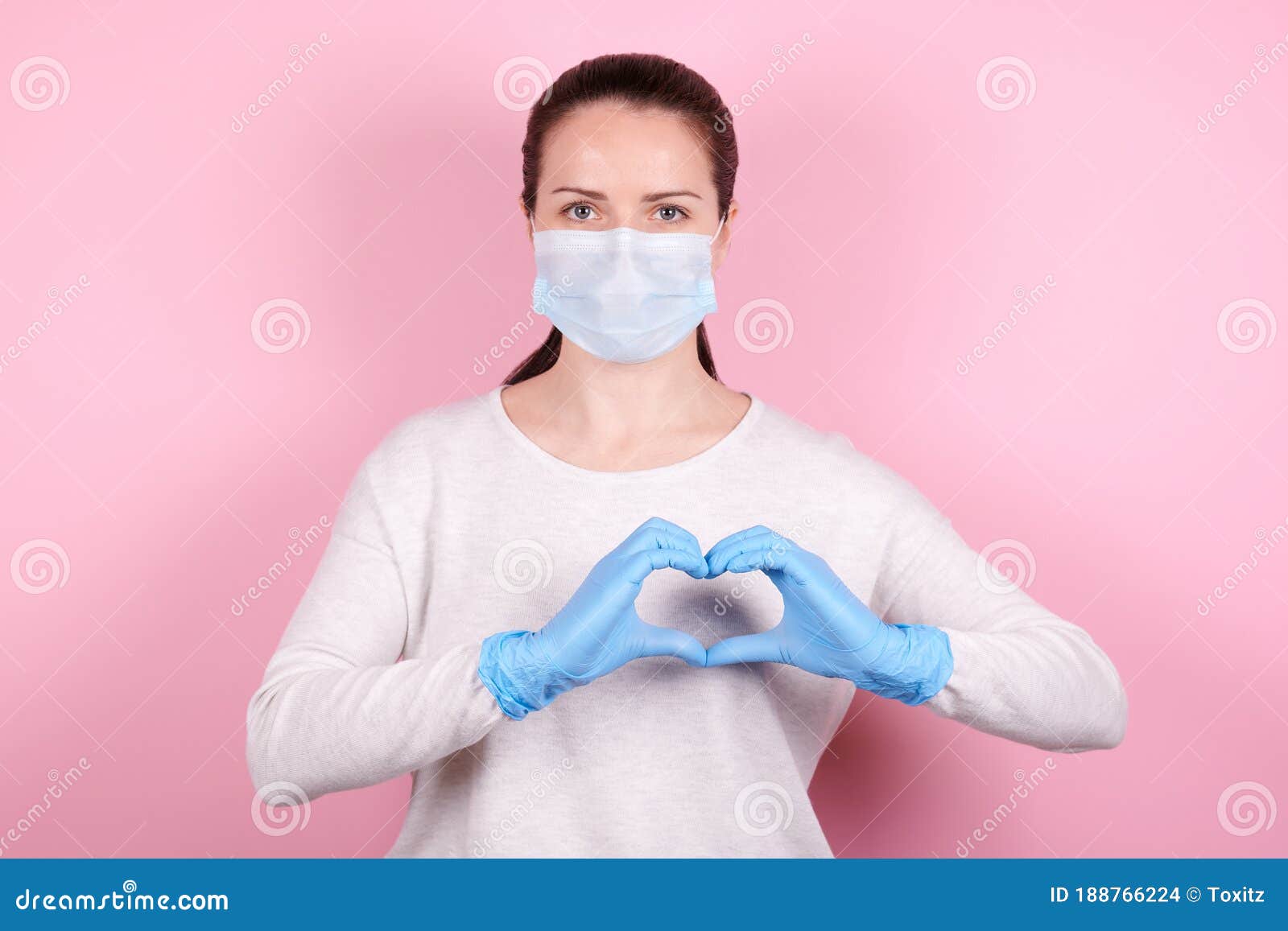 Portrait Of A Brunette Girl In A Medical Mask And Blue Rubber Gloves