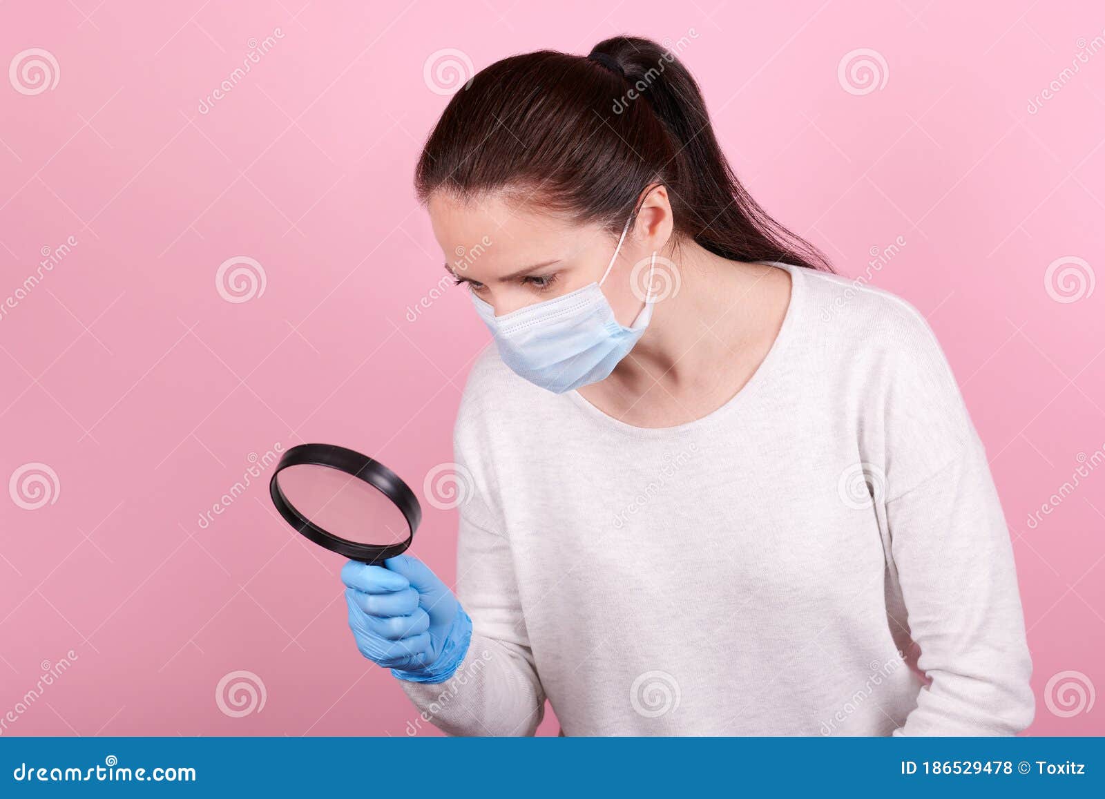 Portrait Of A Brunette Girl In A Medical Mask And Blue Rubber Gloves