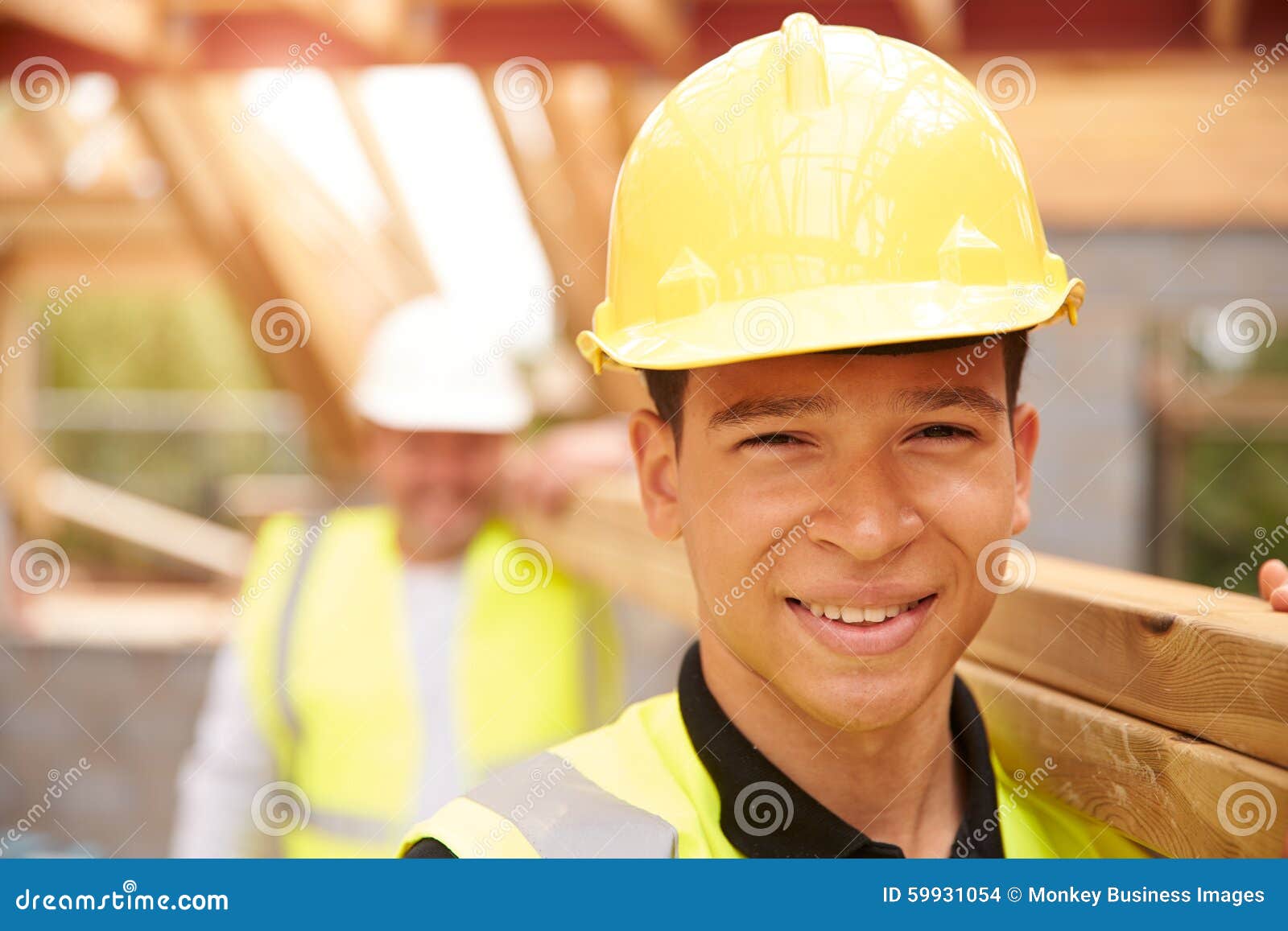 Portrait of Builder and Apprentice Carrying Wood on Site Stock Photo ...