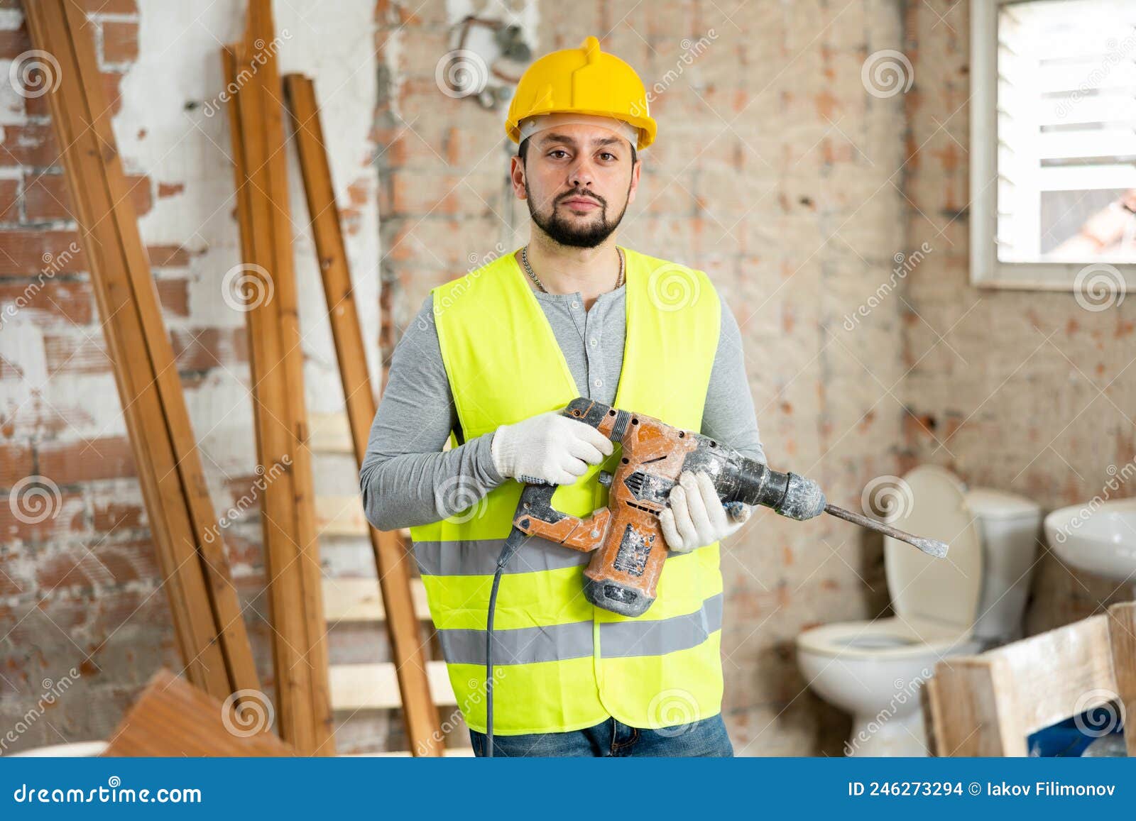 Portrait of a Builder Holding a Hammer Drill in His Hands Stock Photo ...