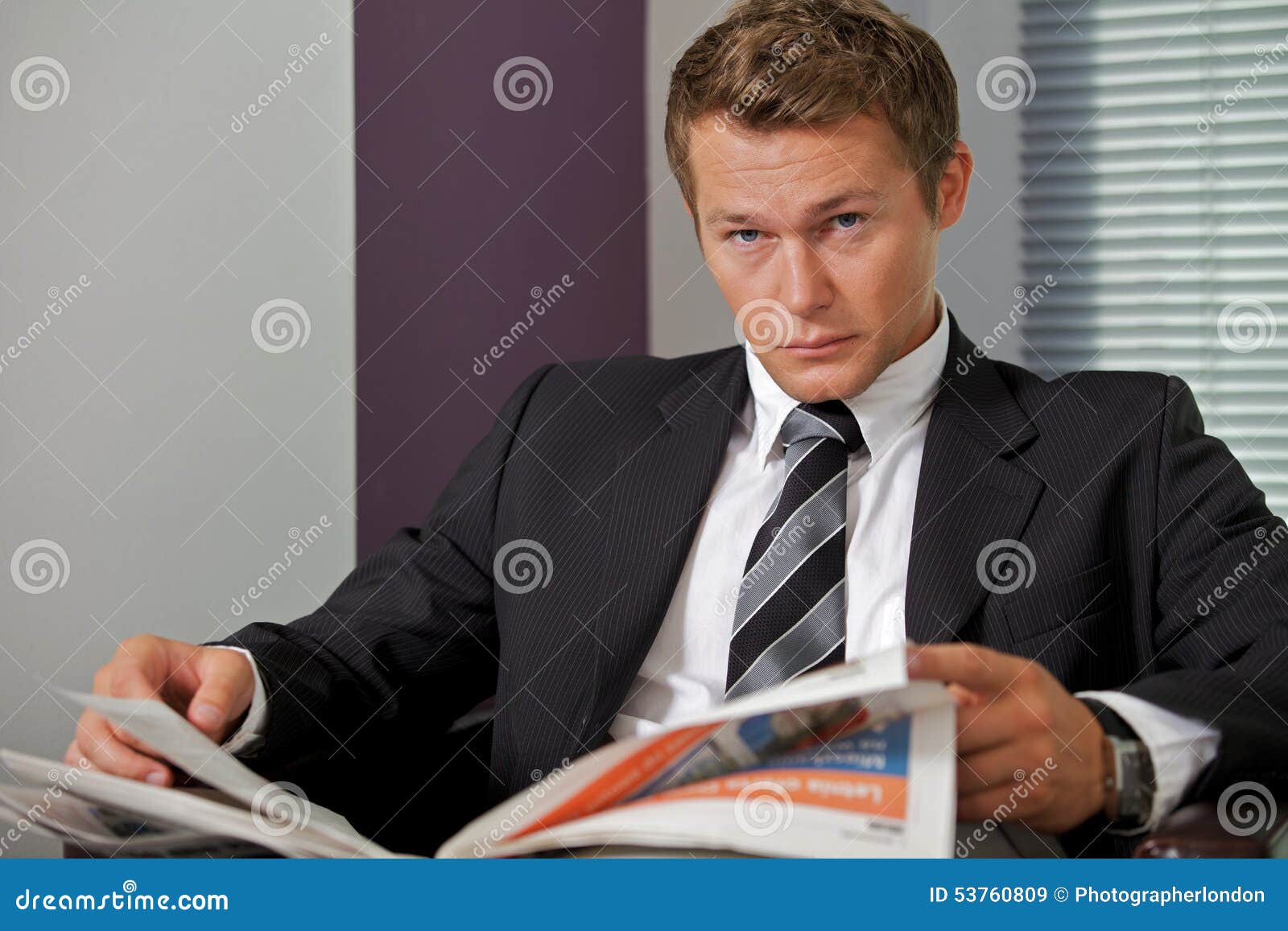 Portrait of Businessman Holding Newspaper in Office Stock Image - Image ...
