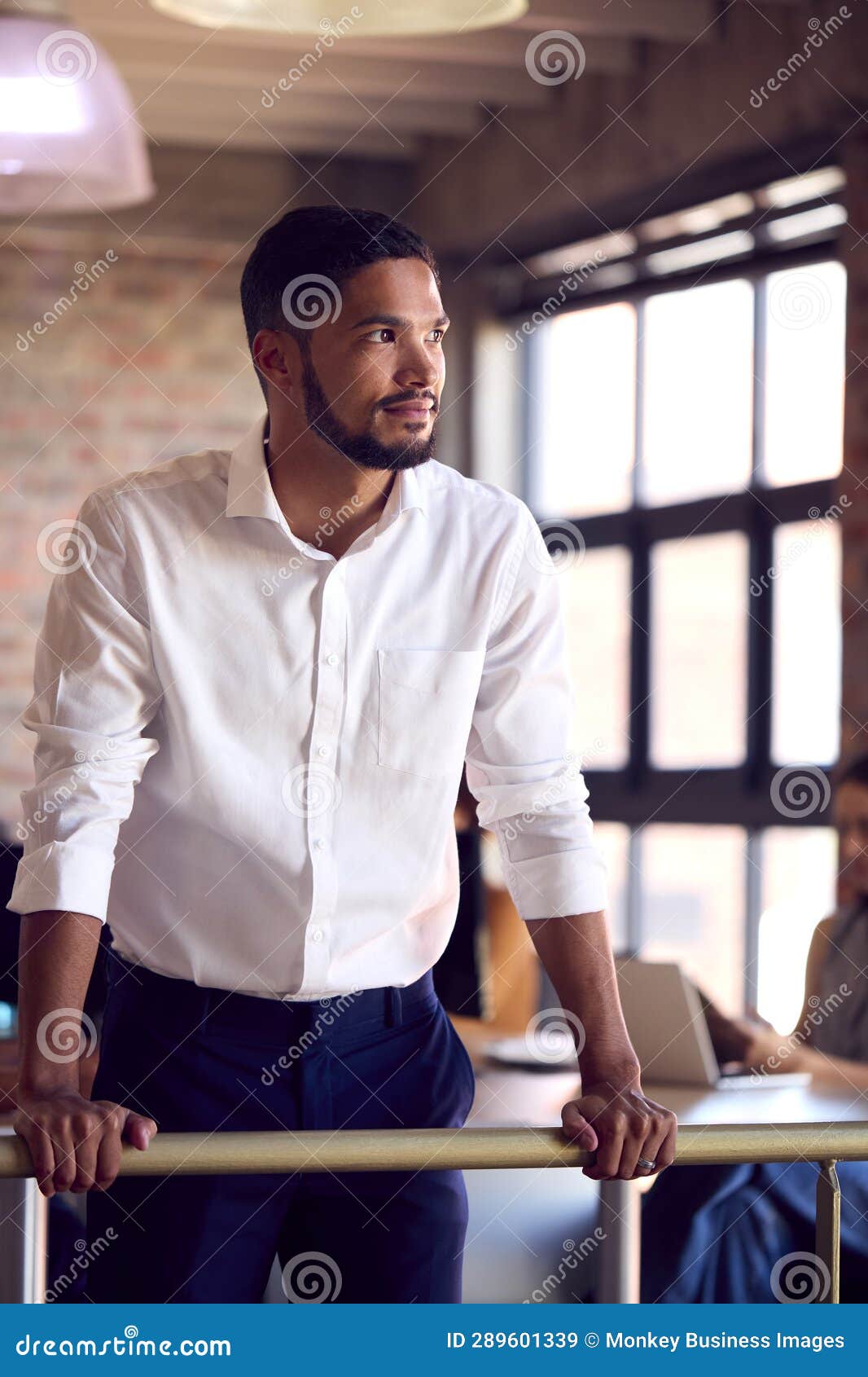 Portrait of Businessman with Serious Expression Standing in Busy Office ...