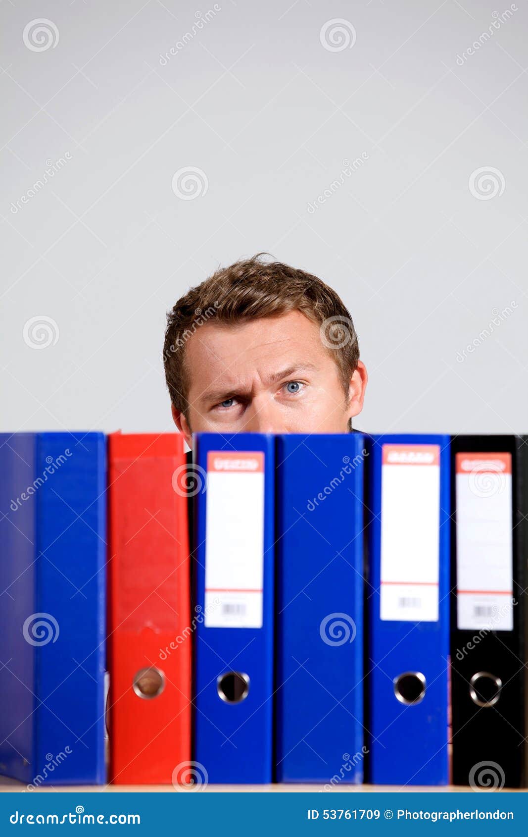 Portrait of Businessman Sitting Behind Files at Office Stock Image ...