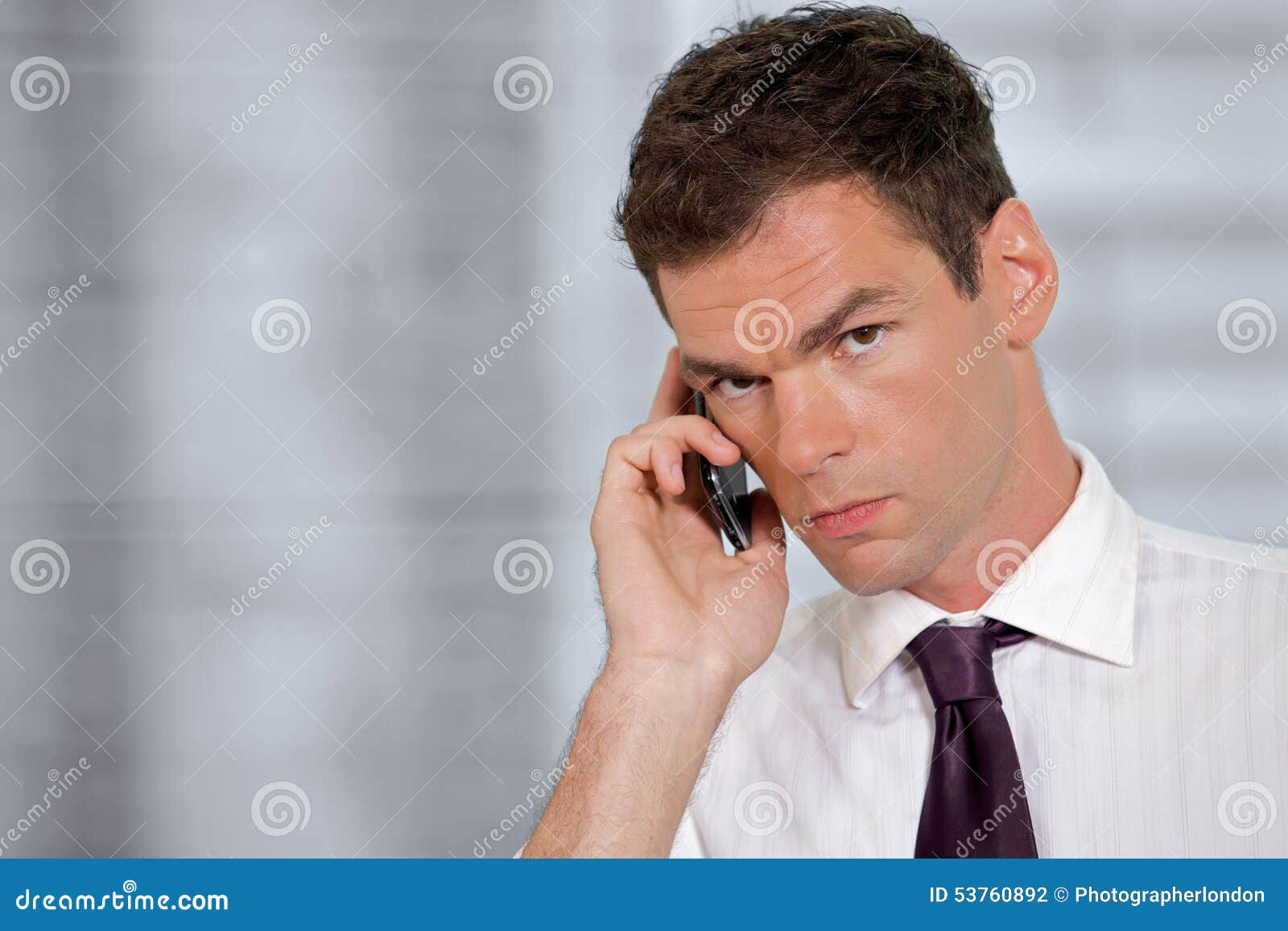 Portrait of Businessman Using Mobile Phone at Office Stock Photo ...