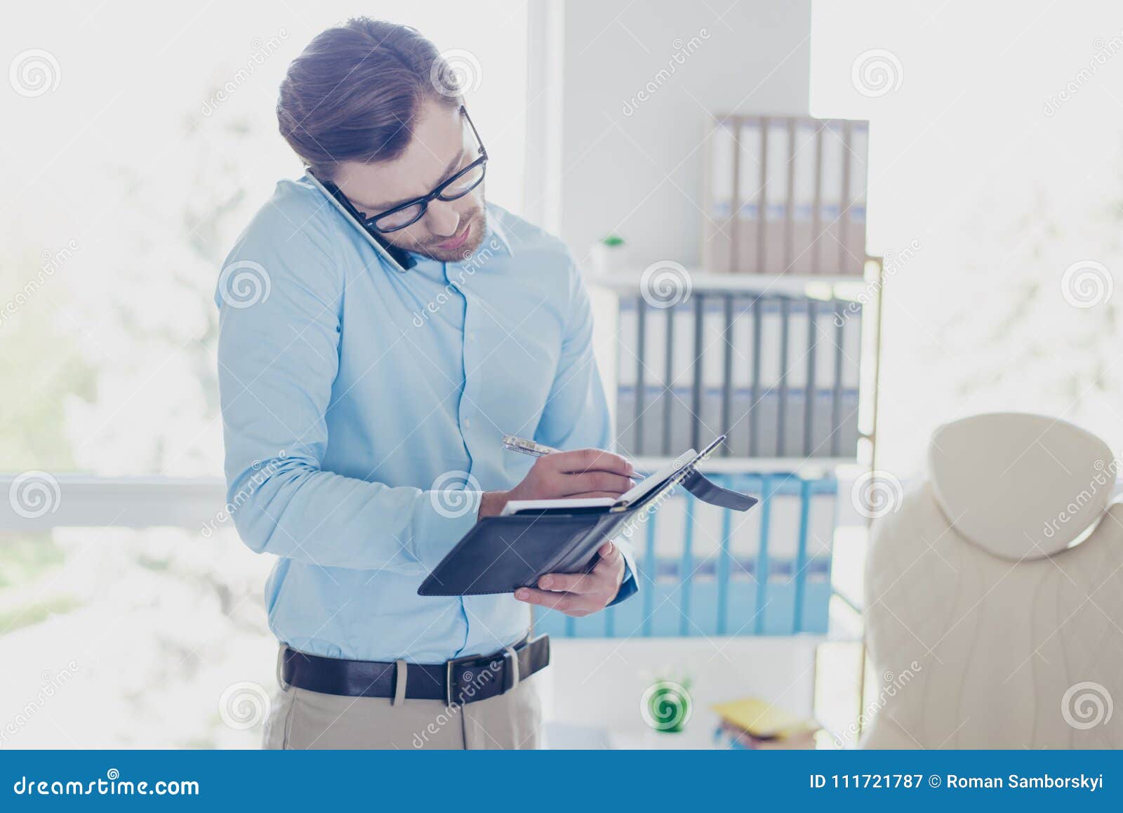 Portrait of Busy and Hard-working Manager. he is Calling To the Stock ...