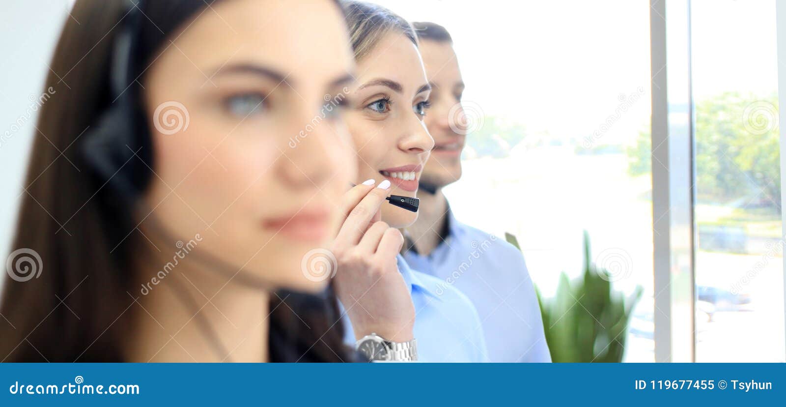 Portrait of Call Center Worker Accompanied by Her Team. Smiling ...