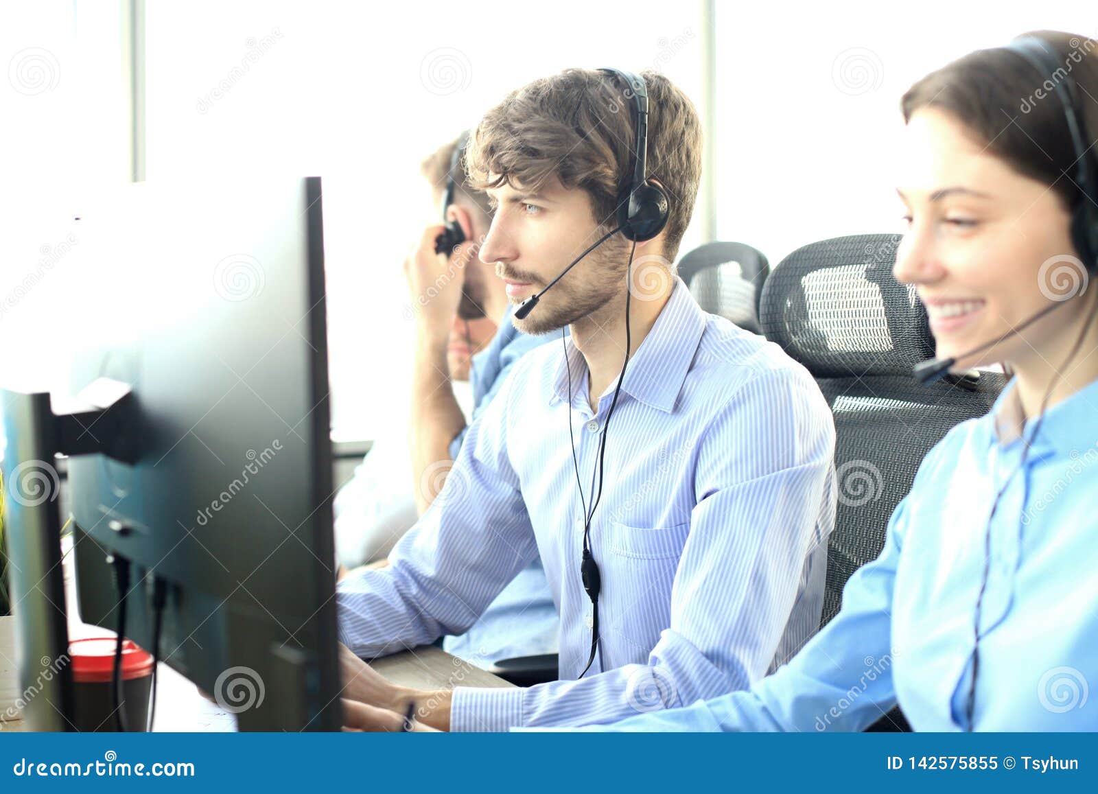 Portrait of Call Center Worker Accompanied by His Team. Smiling ...