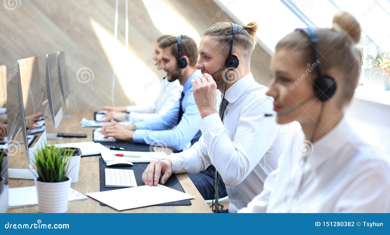 Portrait of Call Center Worker Accompanied by His Team. Smiling ...