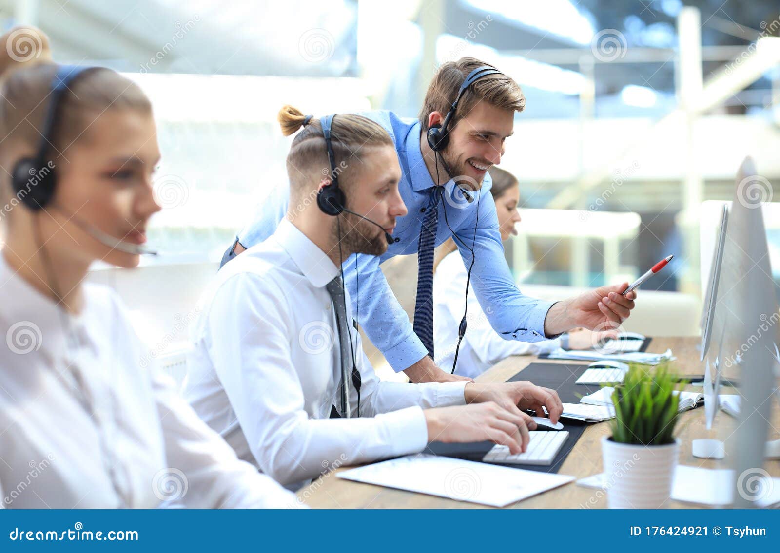 Portrait of Call Center Worker Accompanied by His Team. Smiling ...