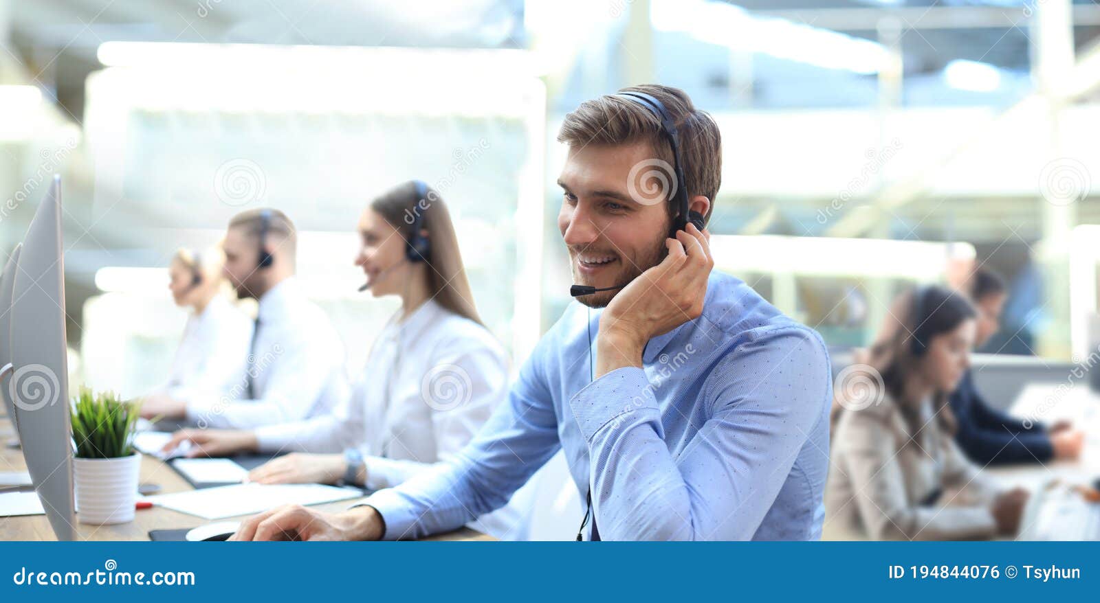 Portrait of Call Center Worker Accompanied by His Team. Smiling ...