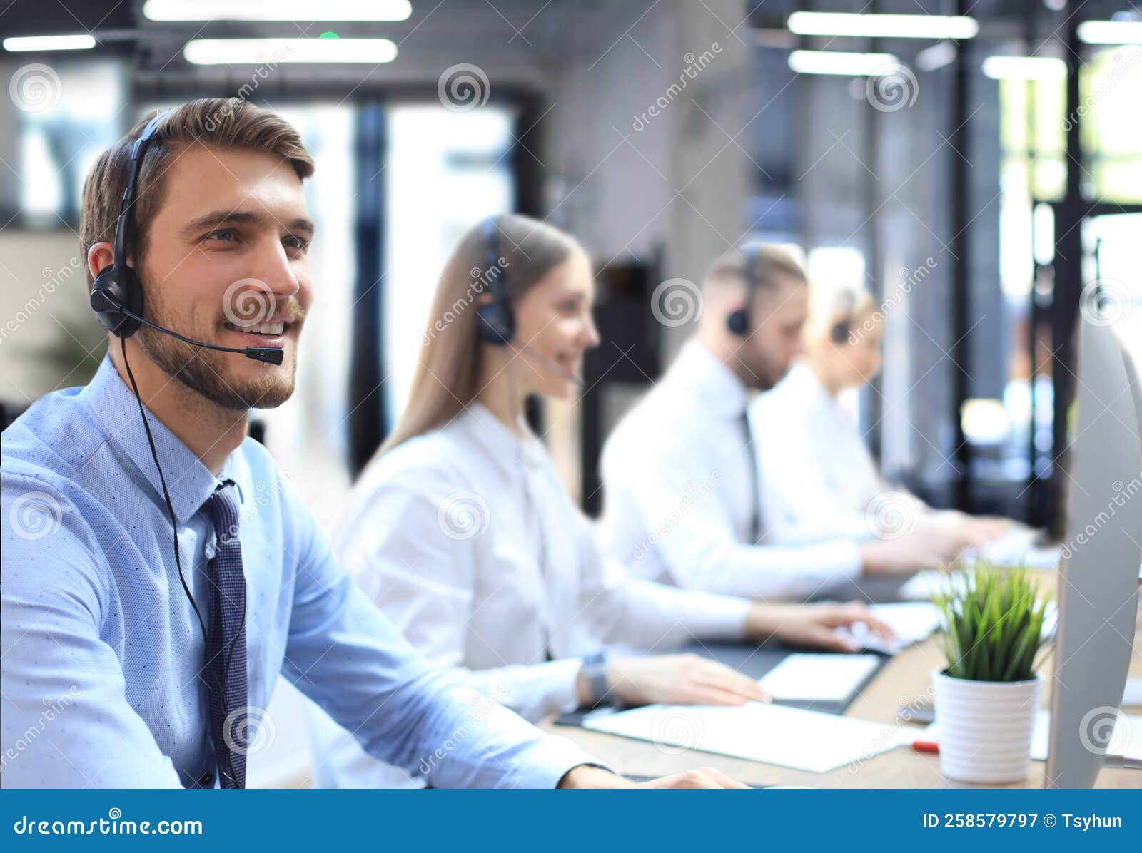 Portrait of Call Center Worker Accompanied by His Team. Smiling ...