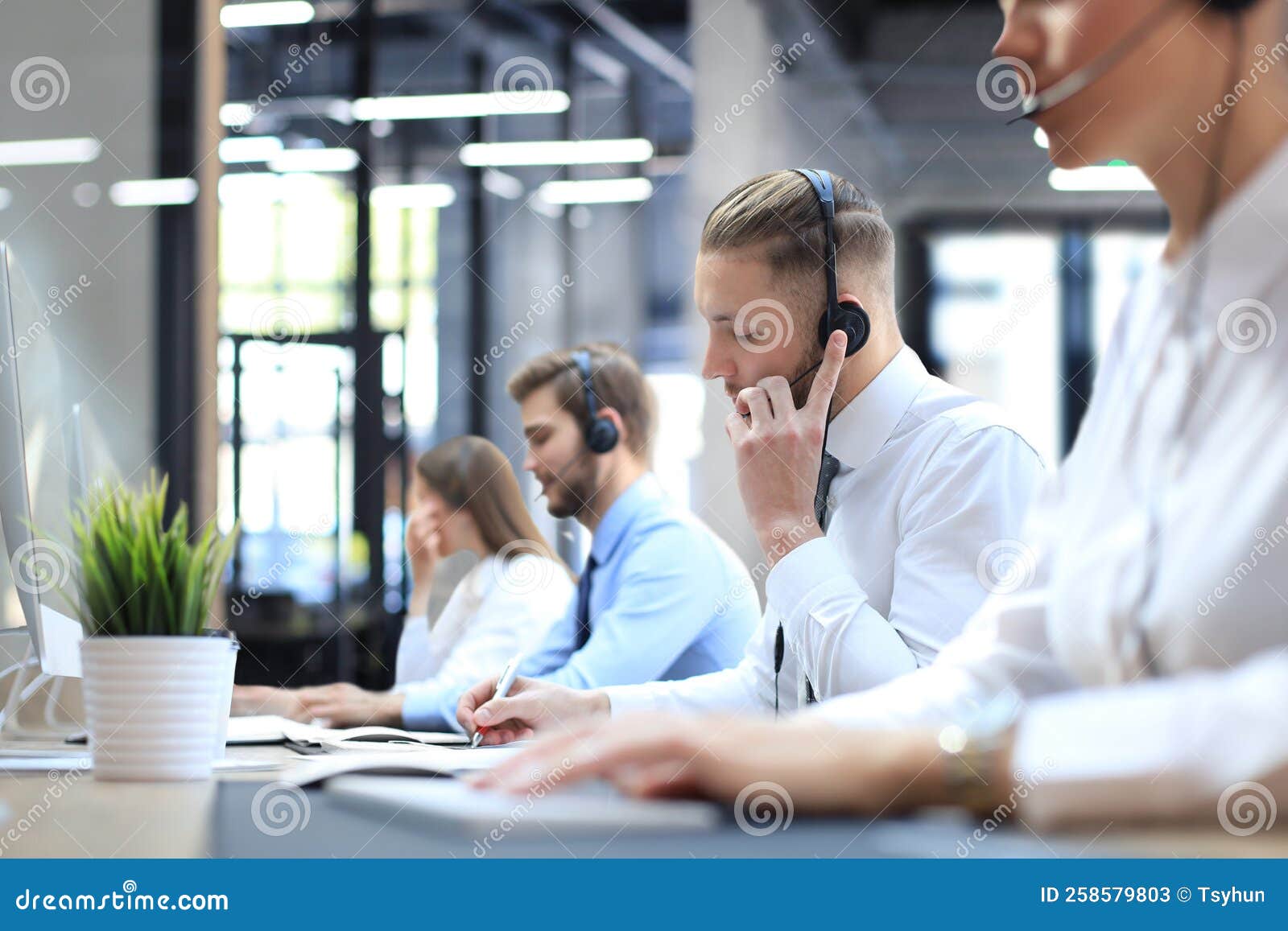 Portrait of Call Center Worker Accompanied by His Team. Smiling ...