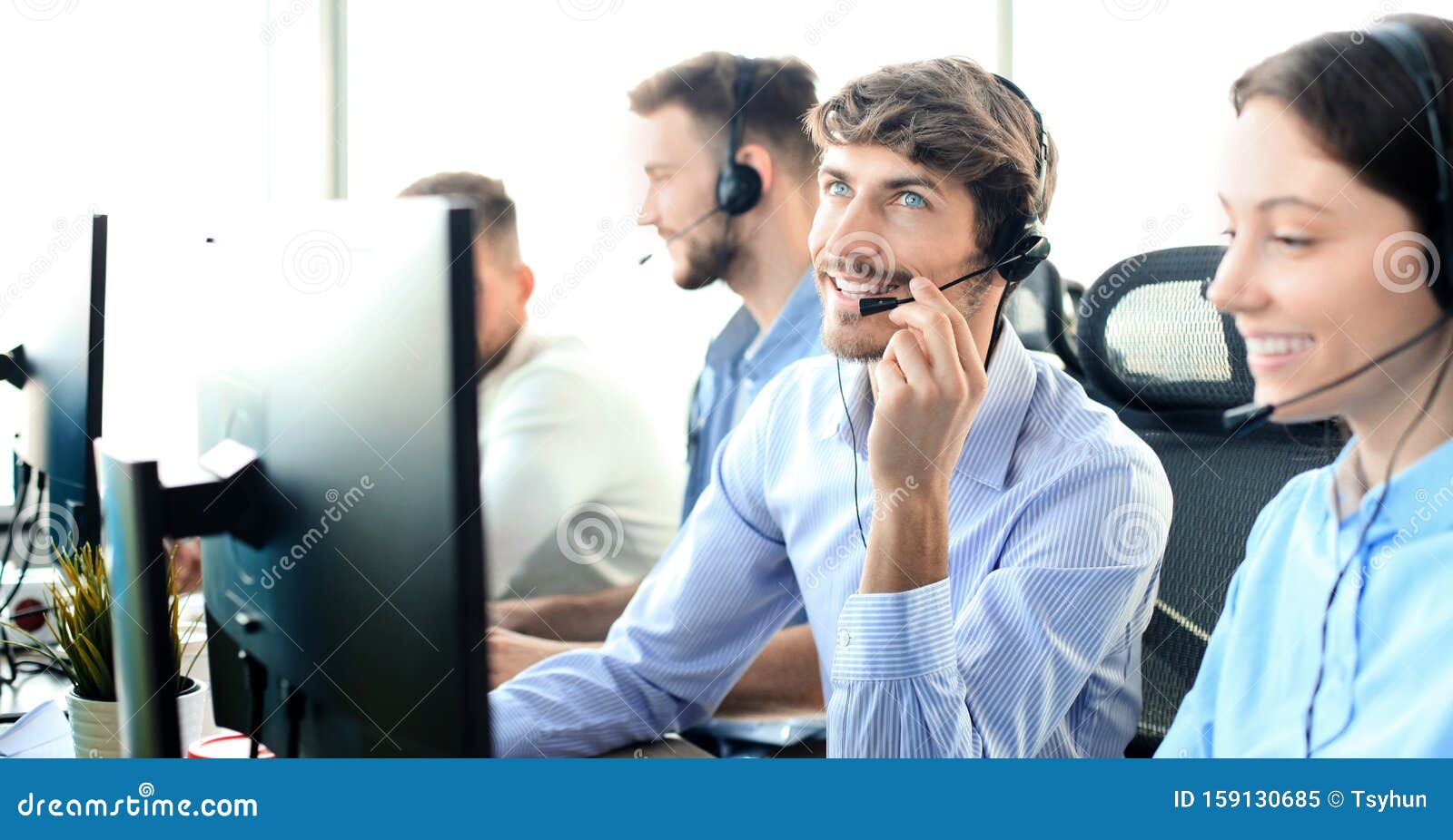 Portrait of Call Center Worker Accompanied by His Team. Smiling ...