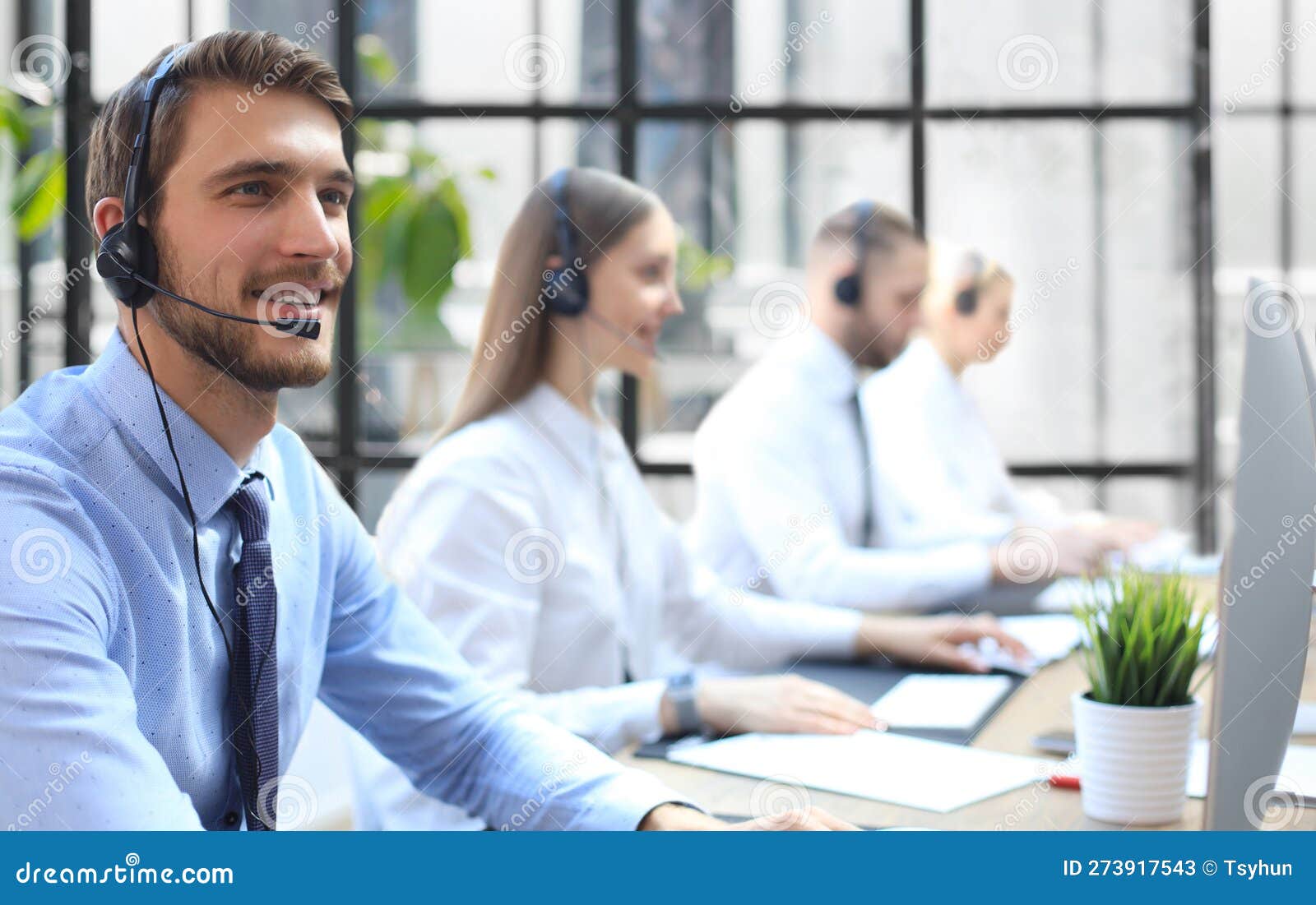Portrait of Call Center Worker Accompanied by His Team. Smiling ...