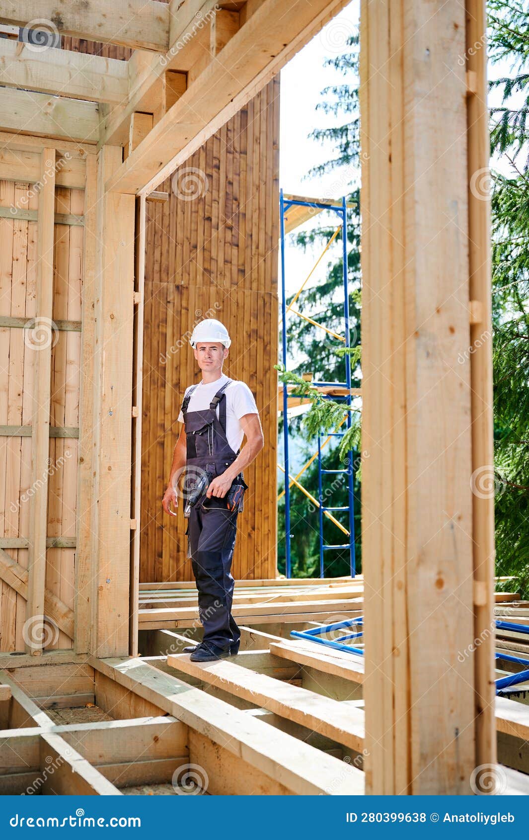 Carpenter Working with Screwdriver while Constructing Wooden Framed ...