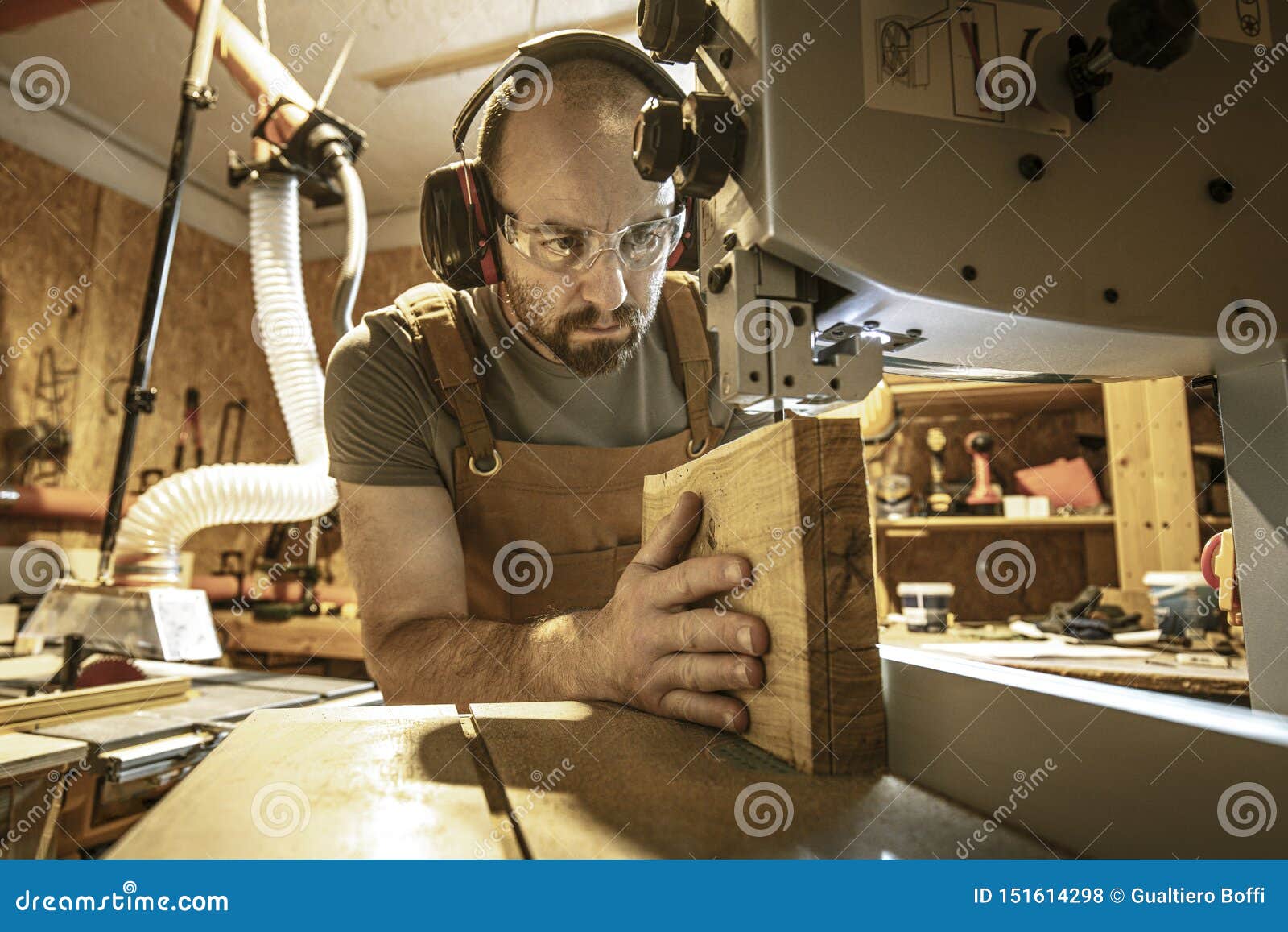 Portrait of a Carpenter Inside His Carpentry Workshop Using a Band Saw ...