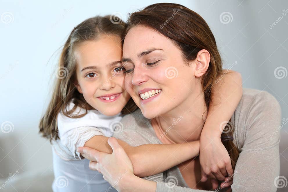 Portrait Of Cheerful Mother And Her Daughter Hugging Her Stock Image