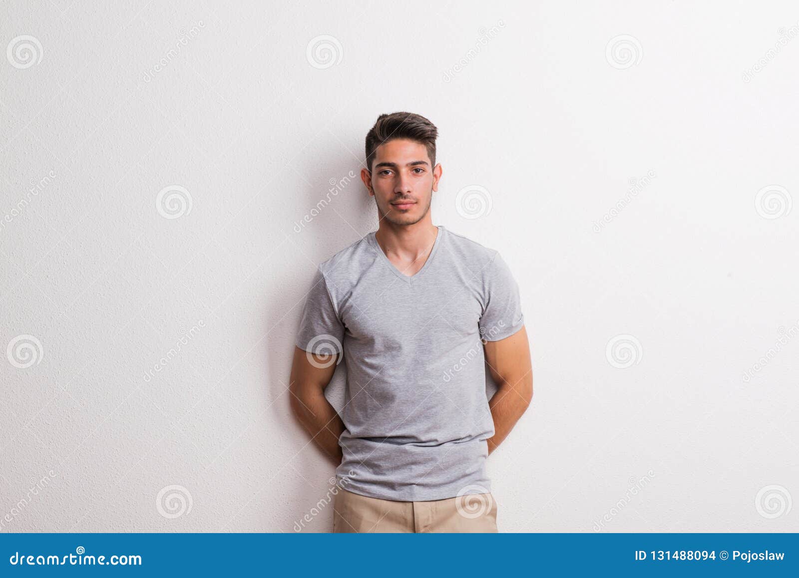 A Cheerful Young Hispanic Man Standing in a Studio. Stock Photo - Image ...