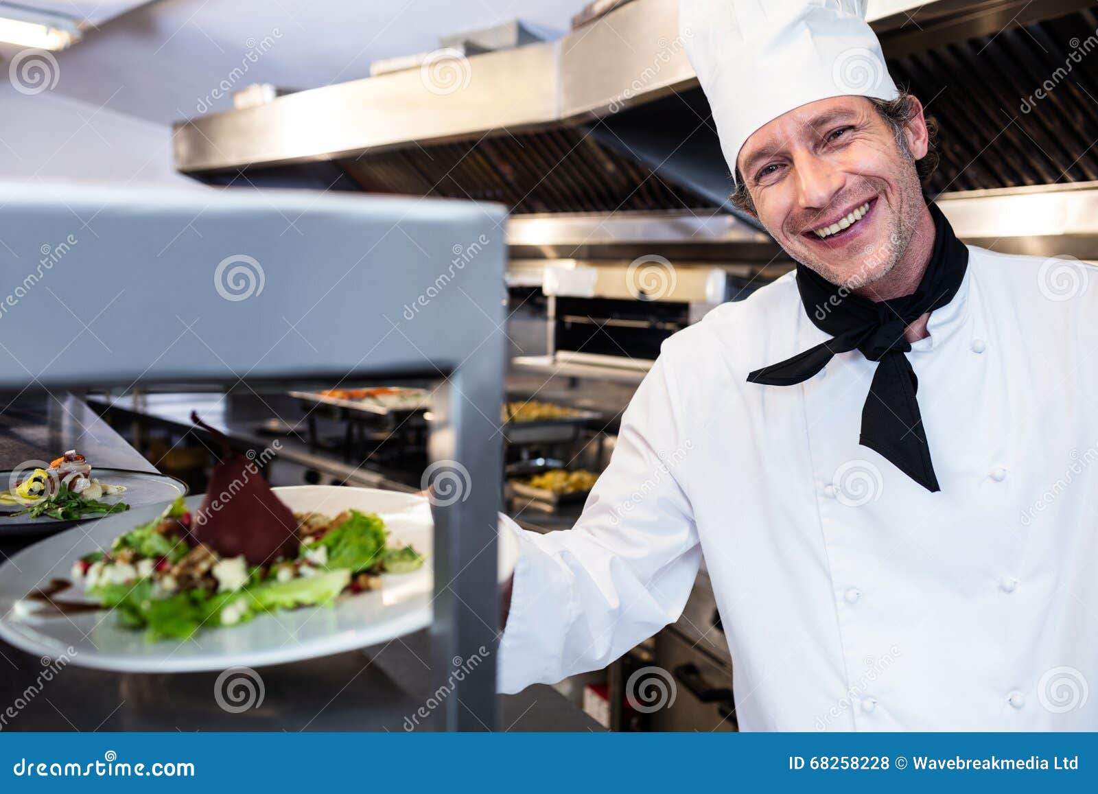 Portrait of a Chef Handing Dinner Plate through Order Station Stock ...