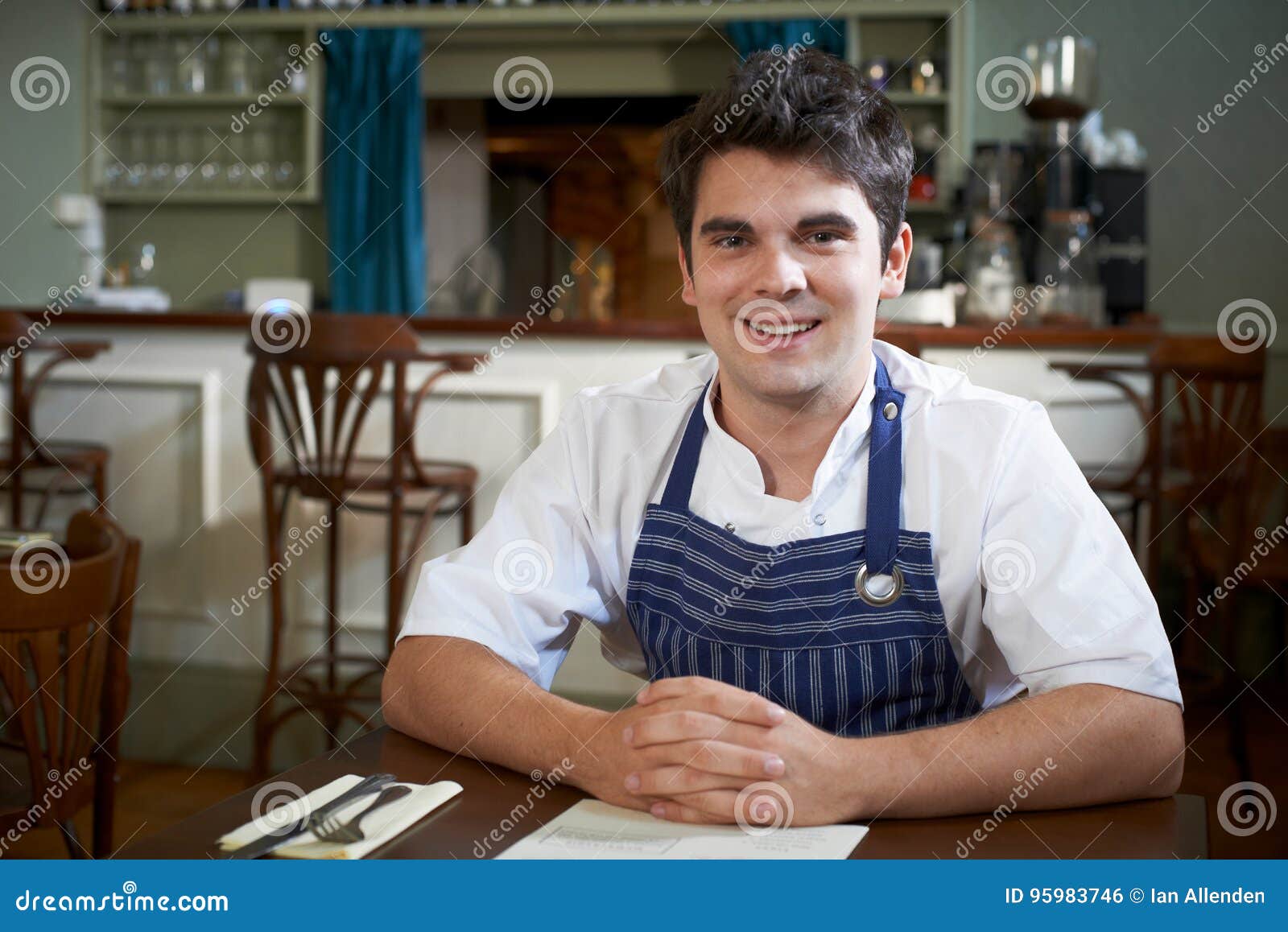 Portrait of Chef Sitting at Table in Restaurant Stock Photo - Image of ...