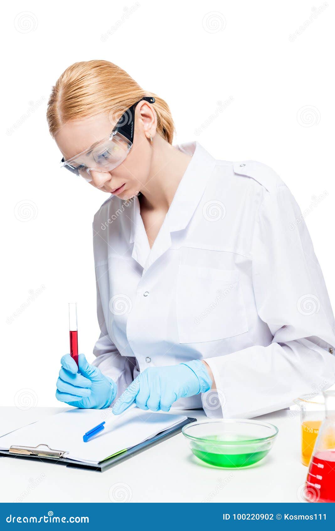Portrait of a Chemist in a Protective Uniform at the Table Working with ...