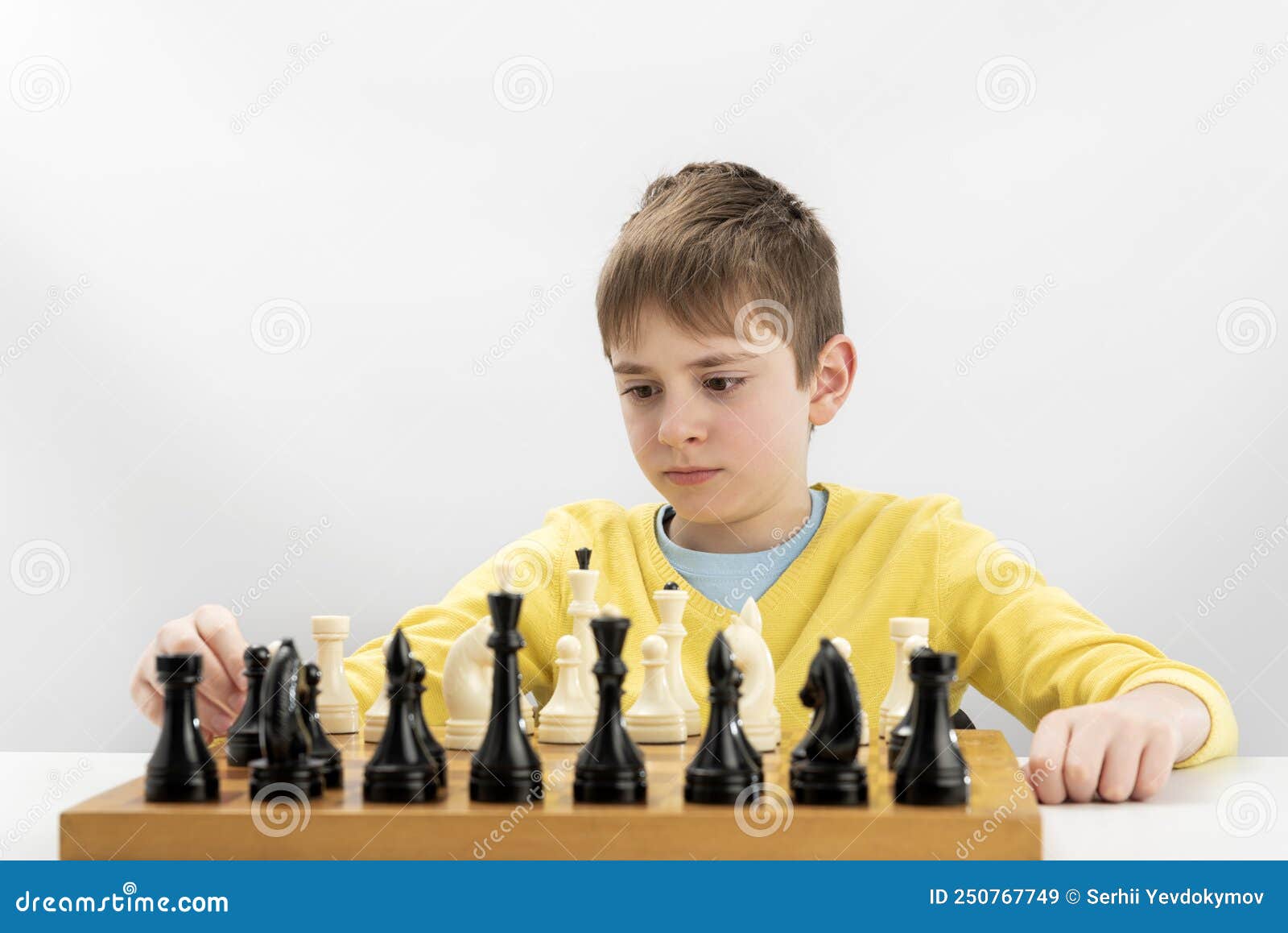 Portrait of Child during Chess Game. Boy Plays Chess and Thinks ...