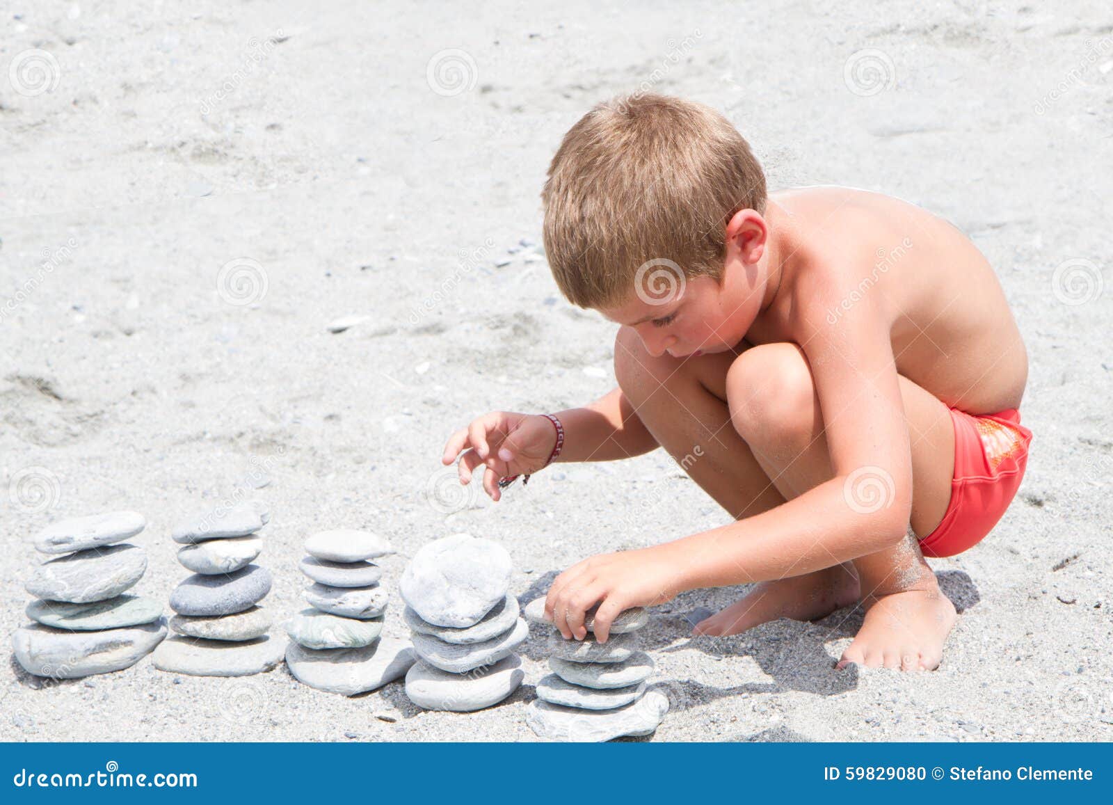 Portrait Child Playing on the Beach, Pile of Stones Stock Photo - Image ...