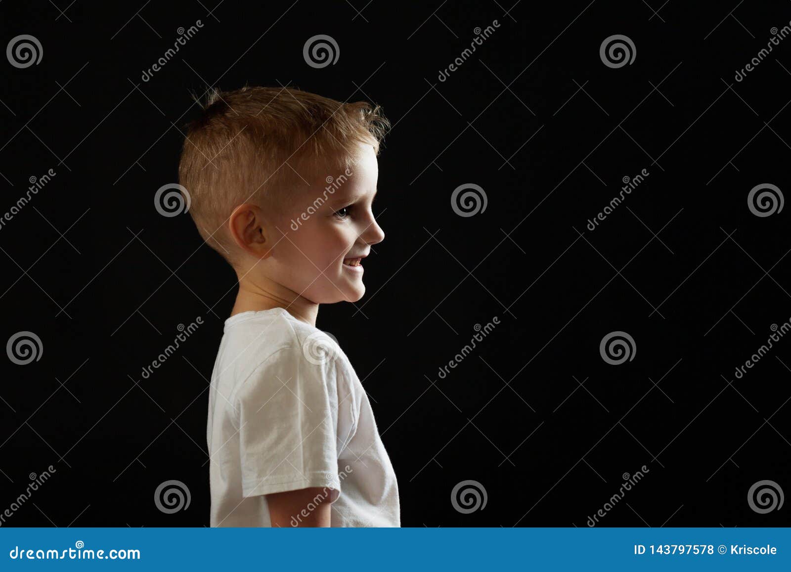 Portrait Of A Child In Profile On A Black Background. Boy Looking ...