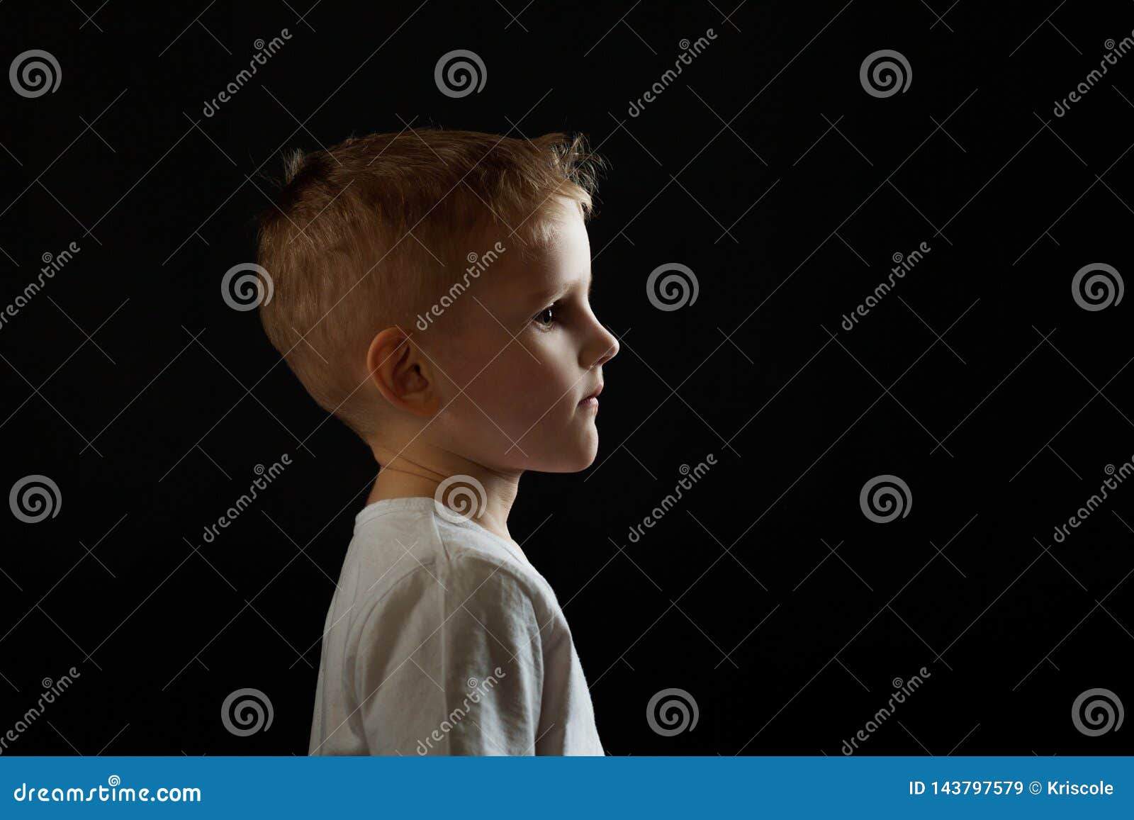 Portrait of a Child in Profile on a Black Background. Boy Looking ...