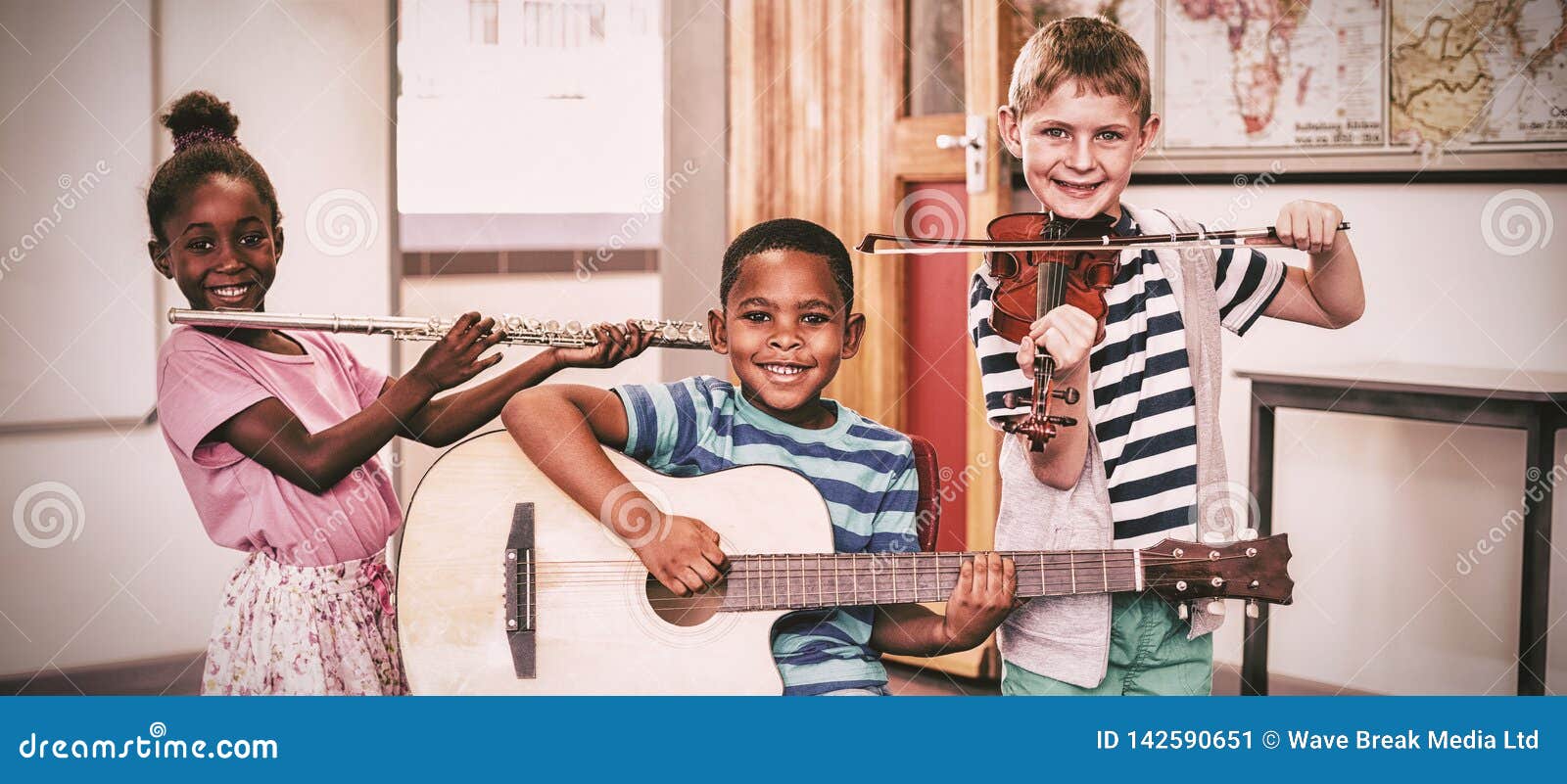 Portrait of Children Playing Musical Instruments in Classroom Stock ...