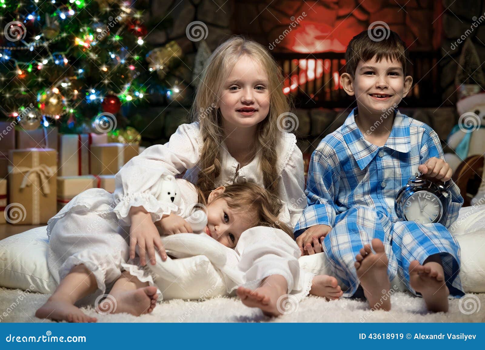Portrait of Children Under the Christmas Tree by the Fireplace Stock ...