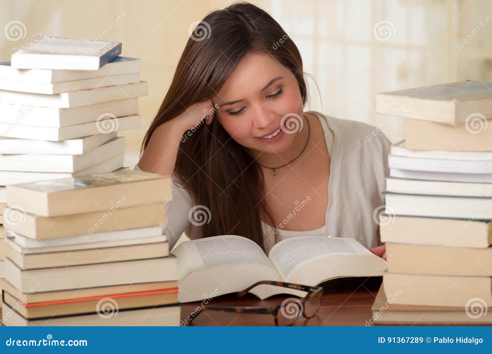 Portrait of Clever Student with Open Book Reading in College Library ...