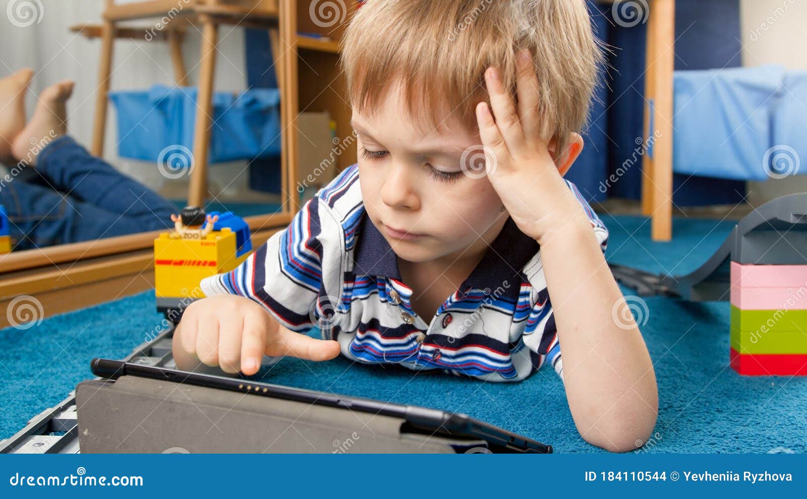 Portrait of Concentrated Little Boy Using Tablet Computer Stock Photo ...