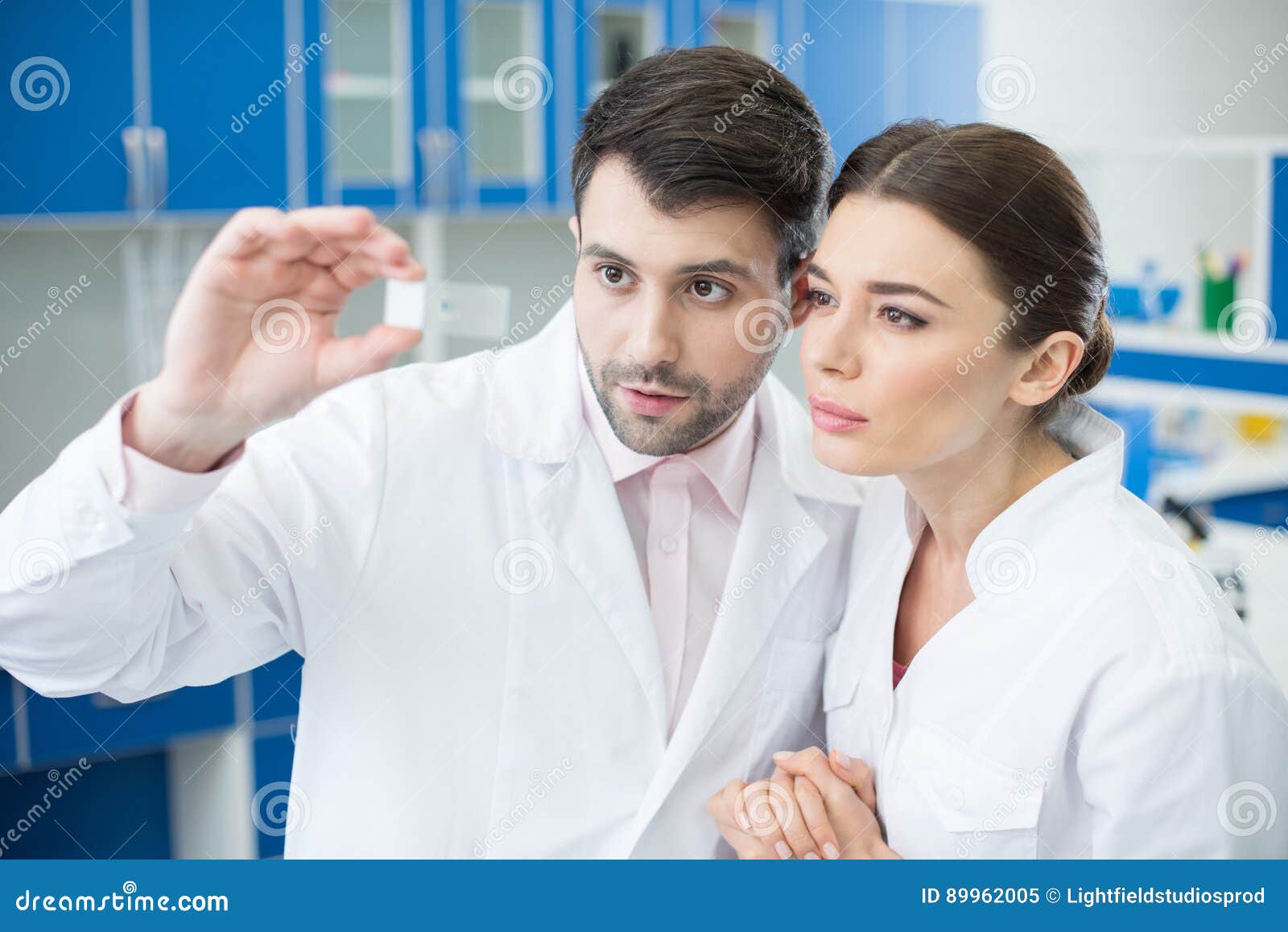 Portrait of Concentrated Scientists Looking at Microscope Slide Stock ...