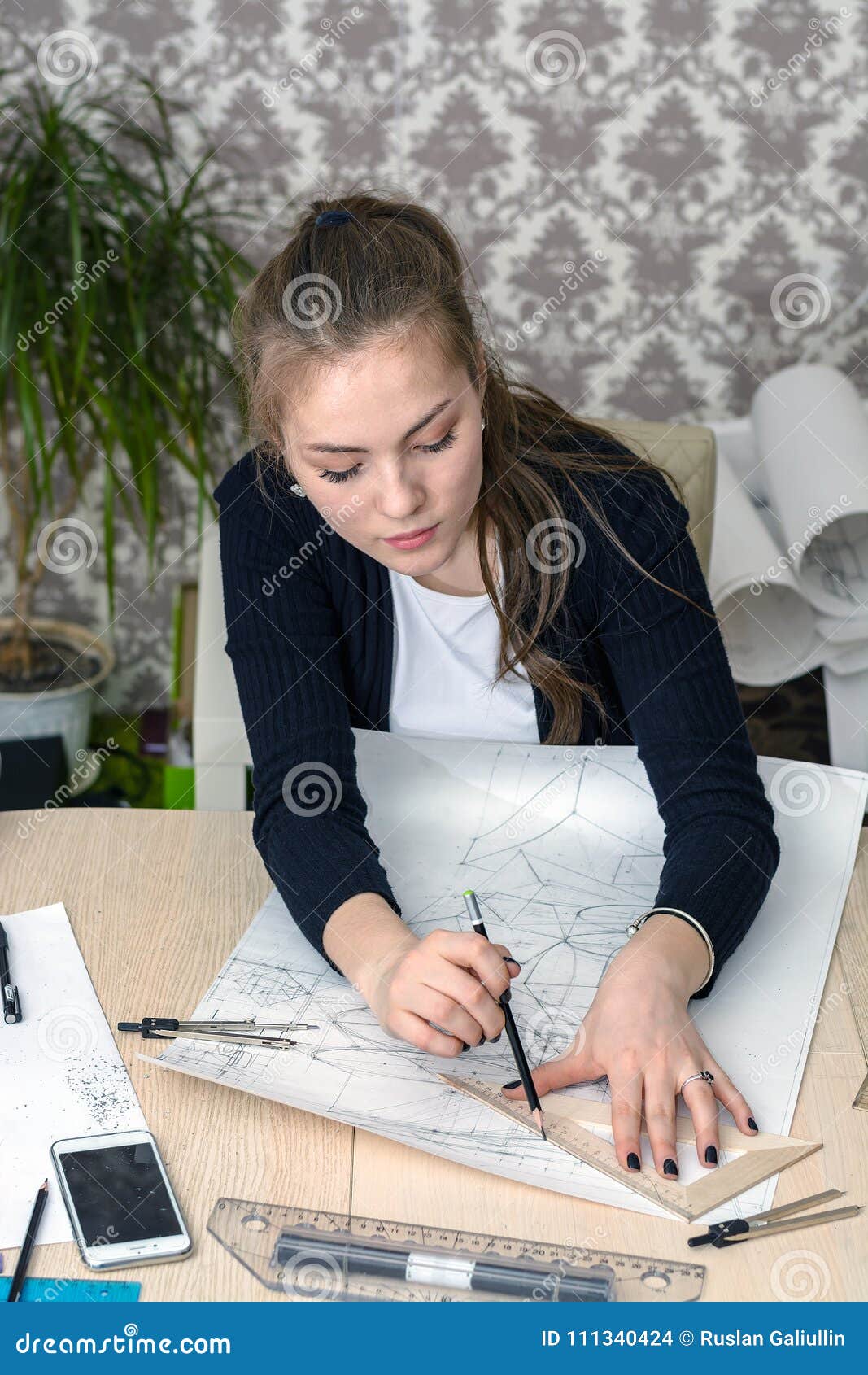 Portrait of a Concentrated Young Student at the Table is Engaged in ...
