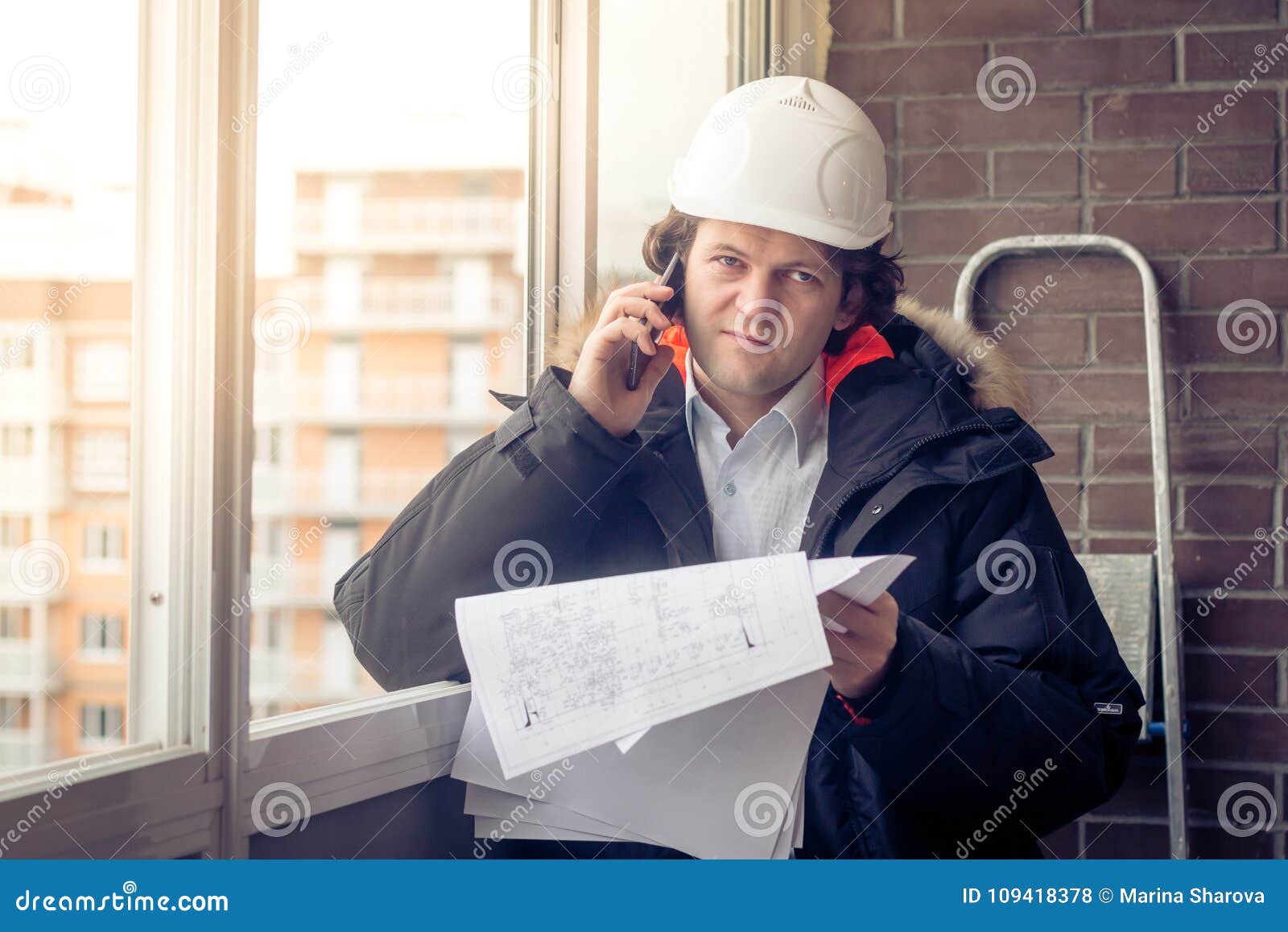 Portrait of Concerned Unshaven Builder Telling by Mobile while Keeping ...