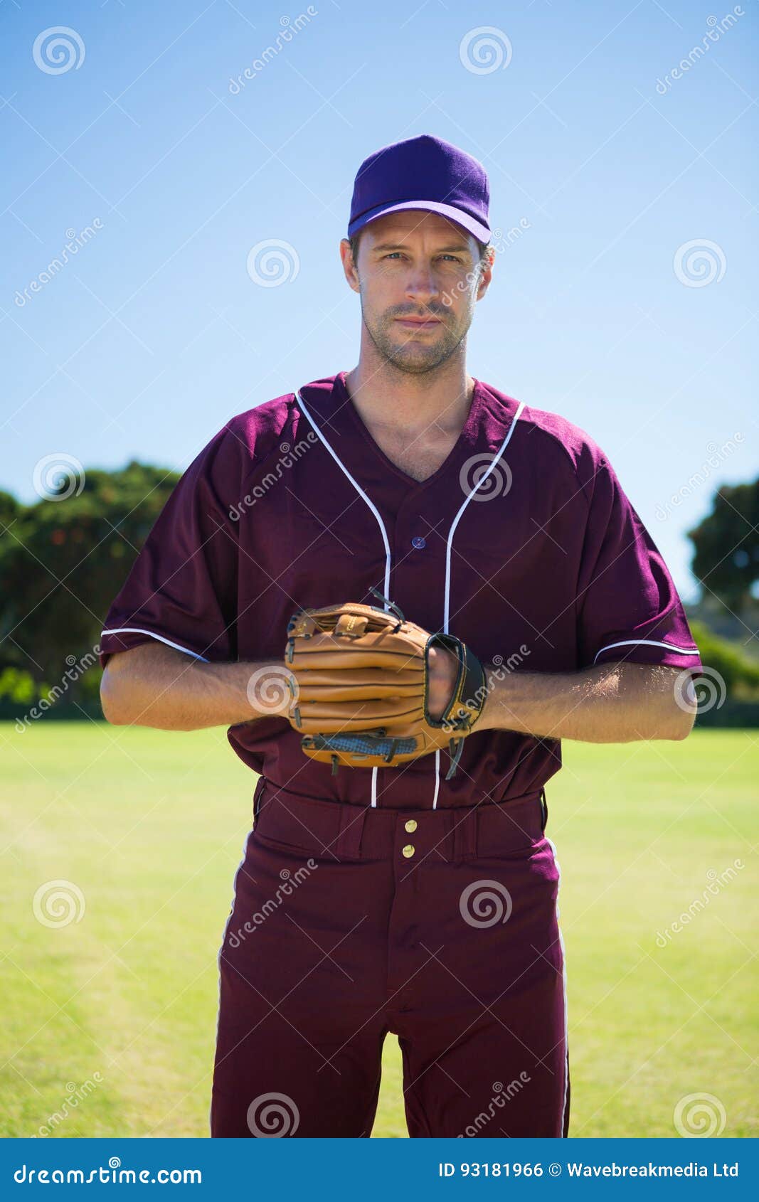 Portrait of Confident Baseball Pitcher Standing Against Sky Stock Photo ...