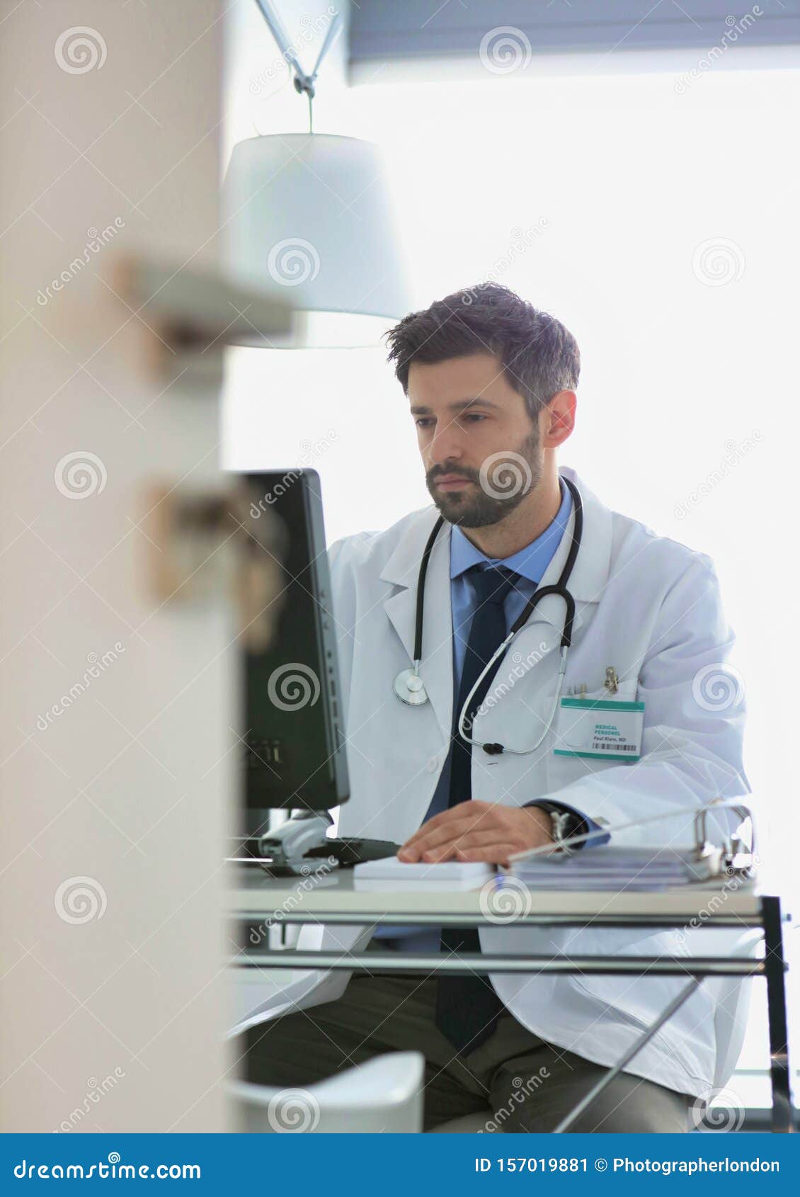 Portrait of Confident Doctor Using Computer at Desk in Hospital Stock ...