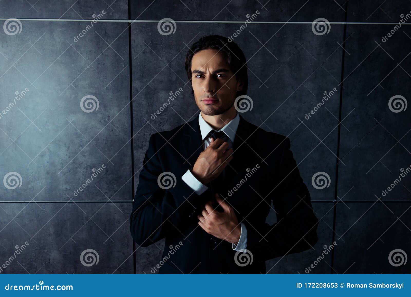 Portrait of Confident Harsh Man Correcting His Black Tie Stock Image ...