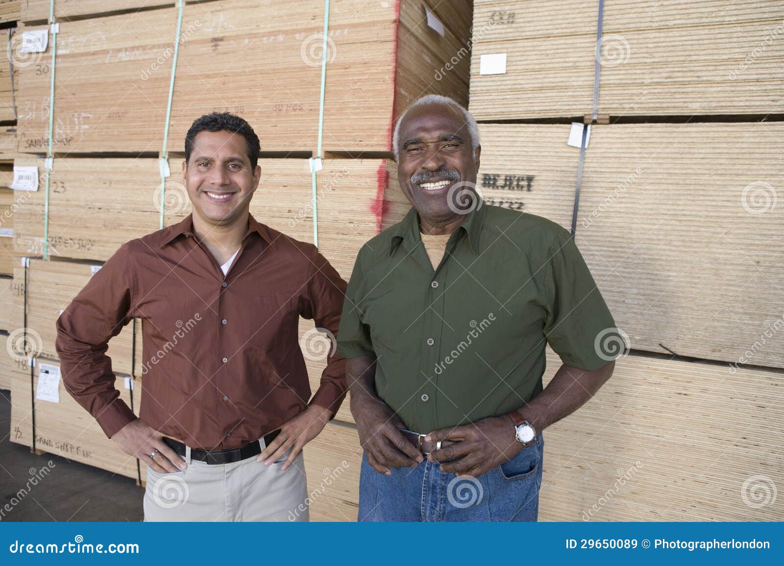 Two Male Warehouse Workers With Hand Pallet Jack Lift Stand Discussing ...