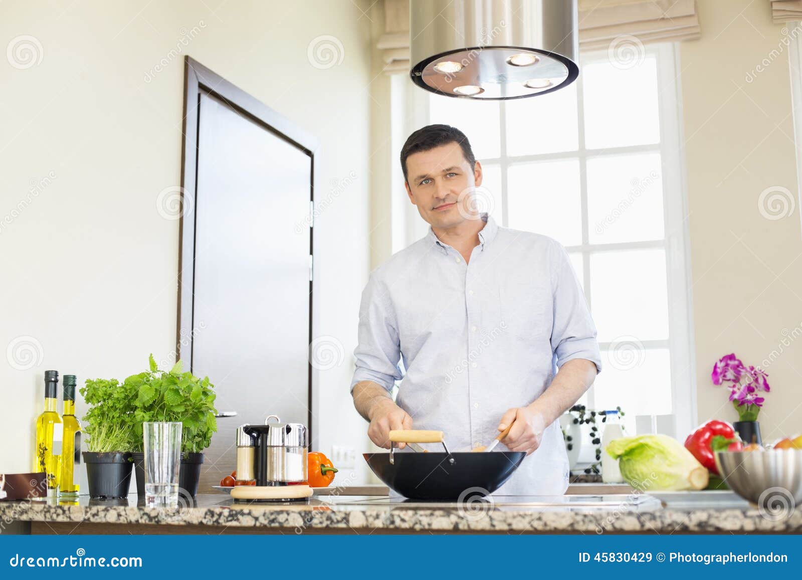 Portrait of Confident Man Preparing Food in Kitchen Stock Image - Image ...