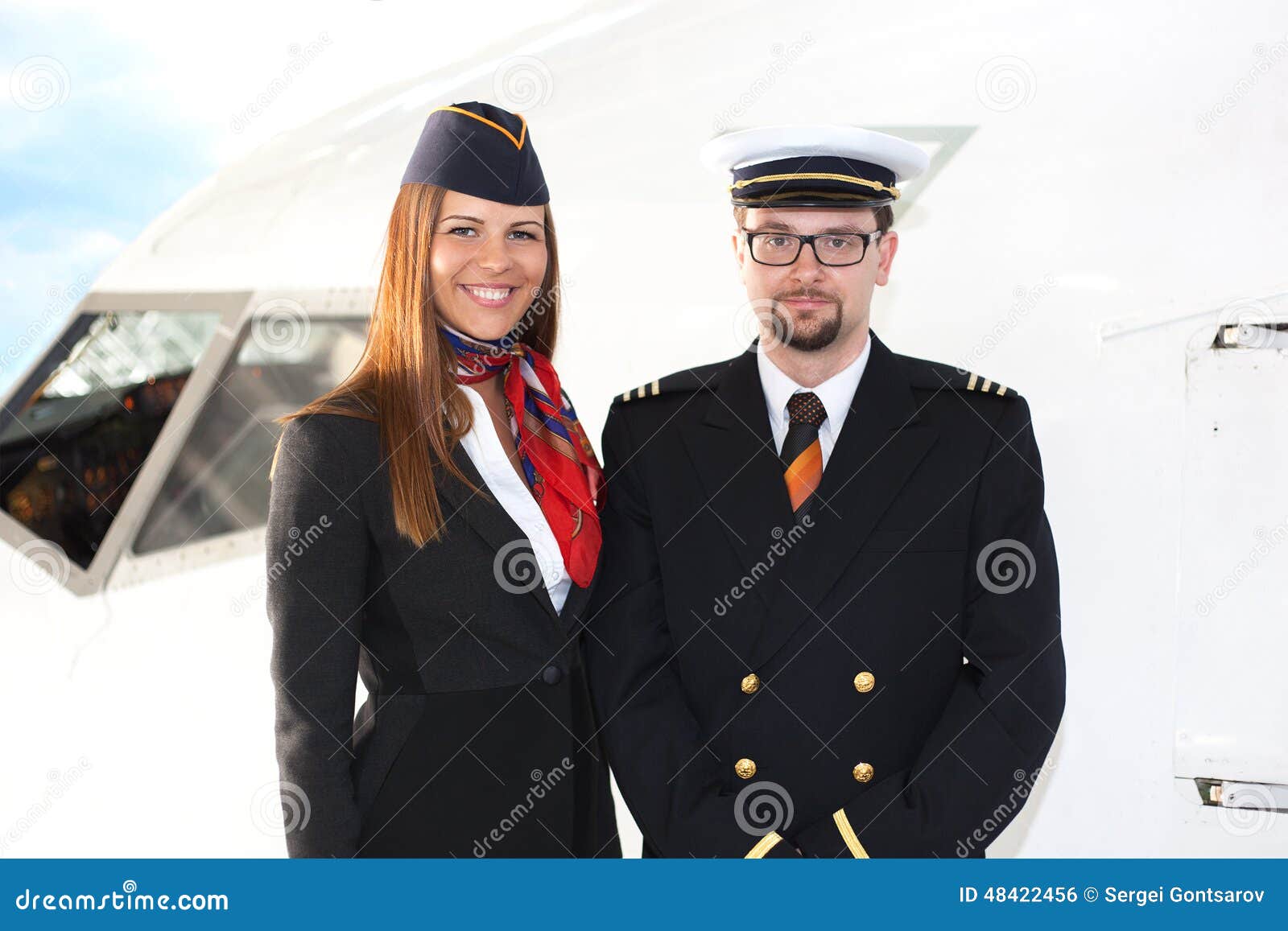 Portrait of Confident Stewardess and Pilot Standing Against Plane Stock ...
