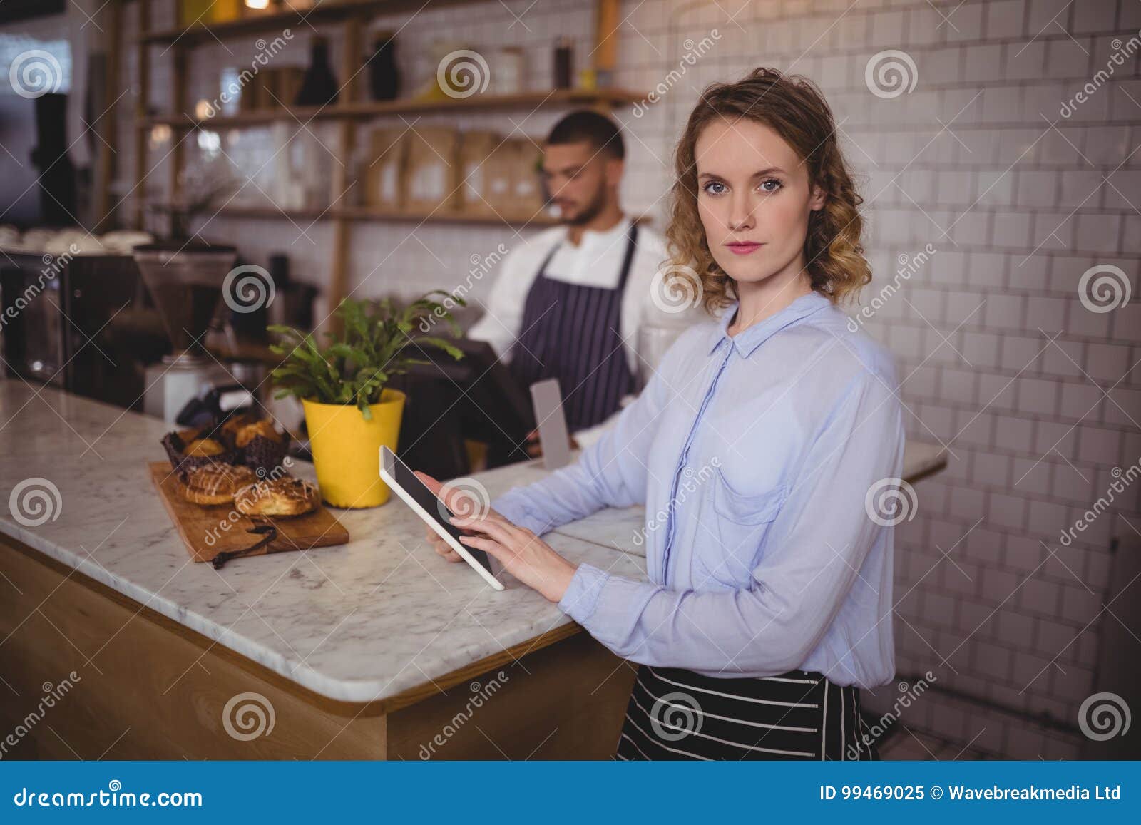 Portrait of Confident Waitress Using Digital Tablet while Standing at ...